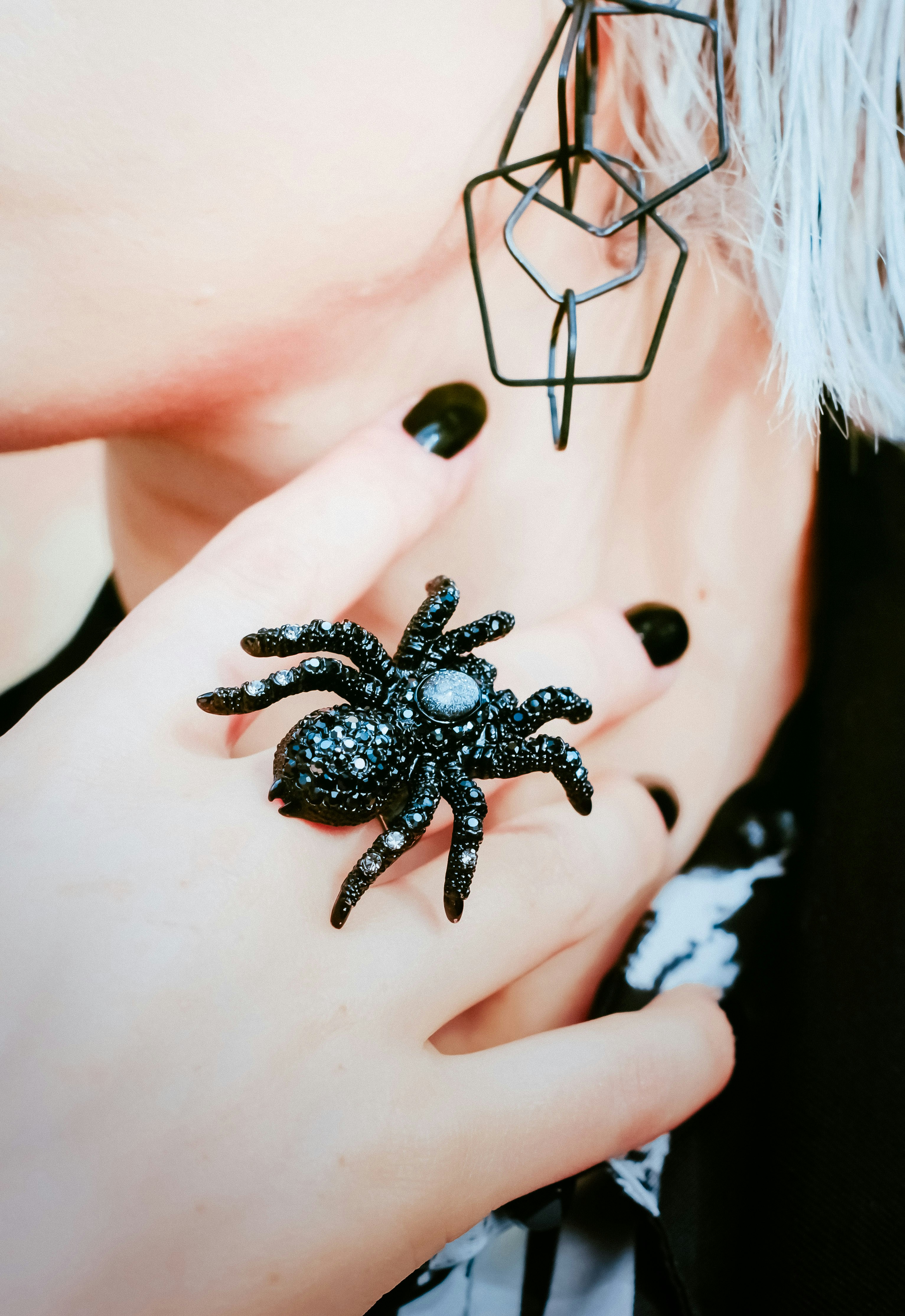 Bejeweled Spider Ring on Pale Skin: Close-Up of Gothic Glam Jewelry