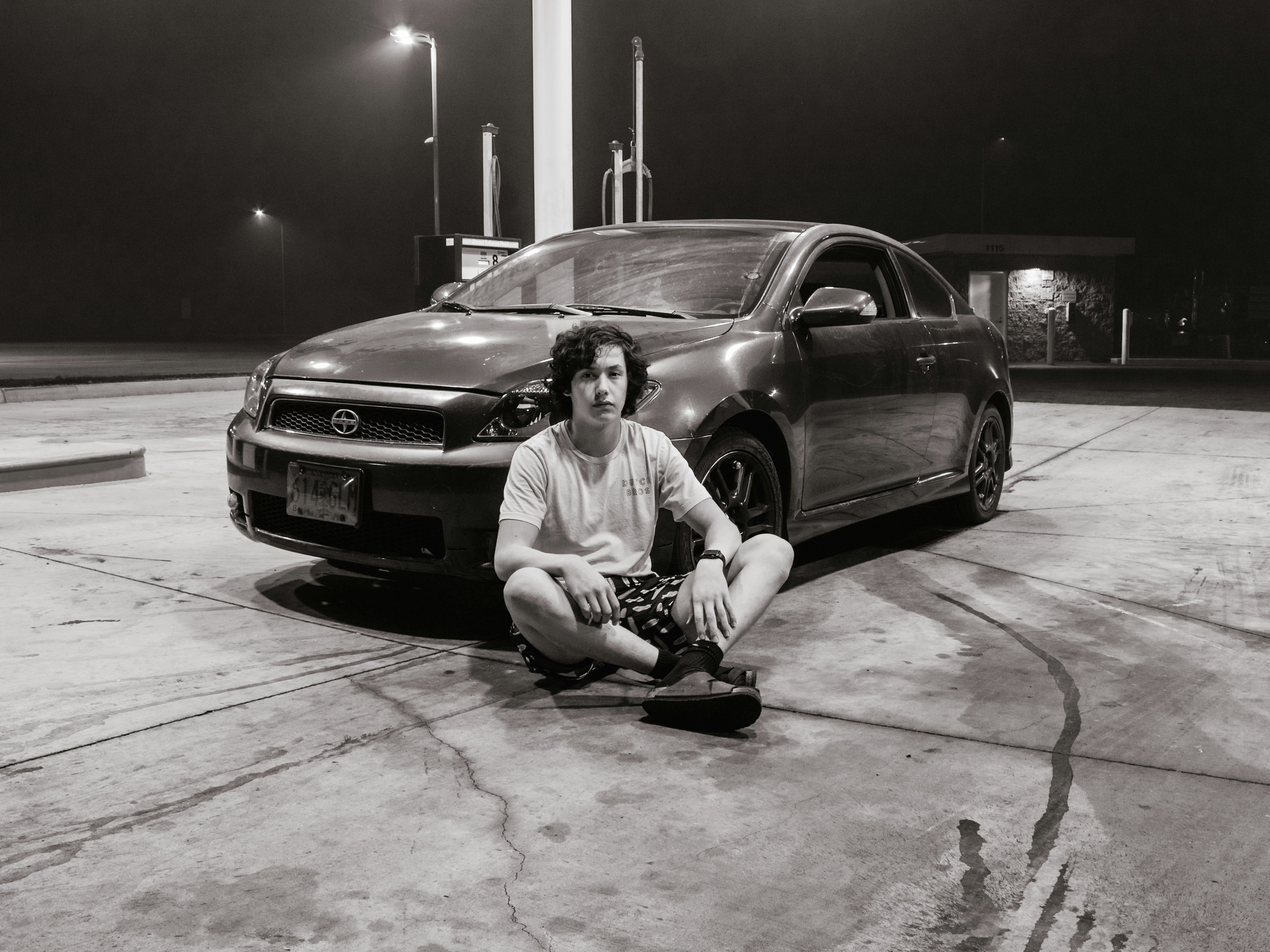 Sitting in the Moonlit Parking Lot: A Teen Rebel and a Sedan