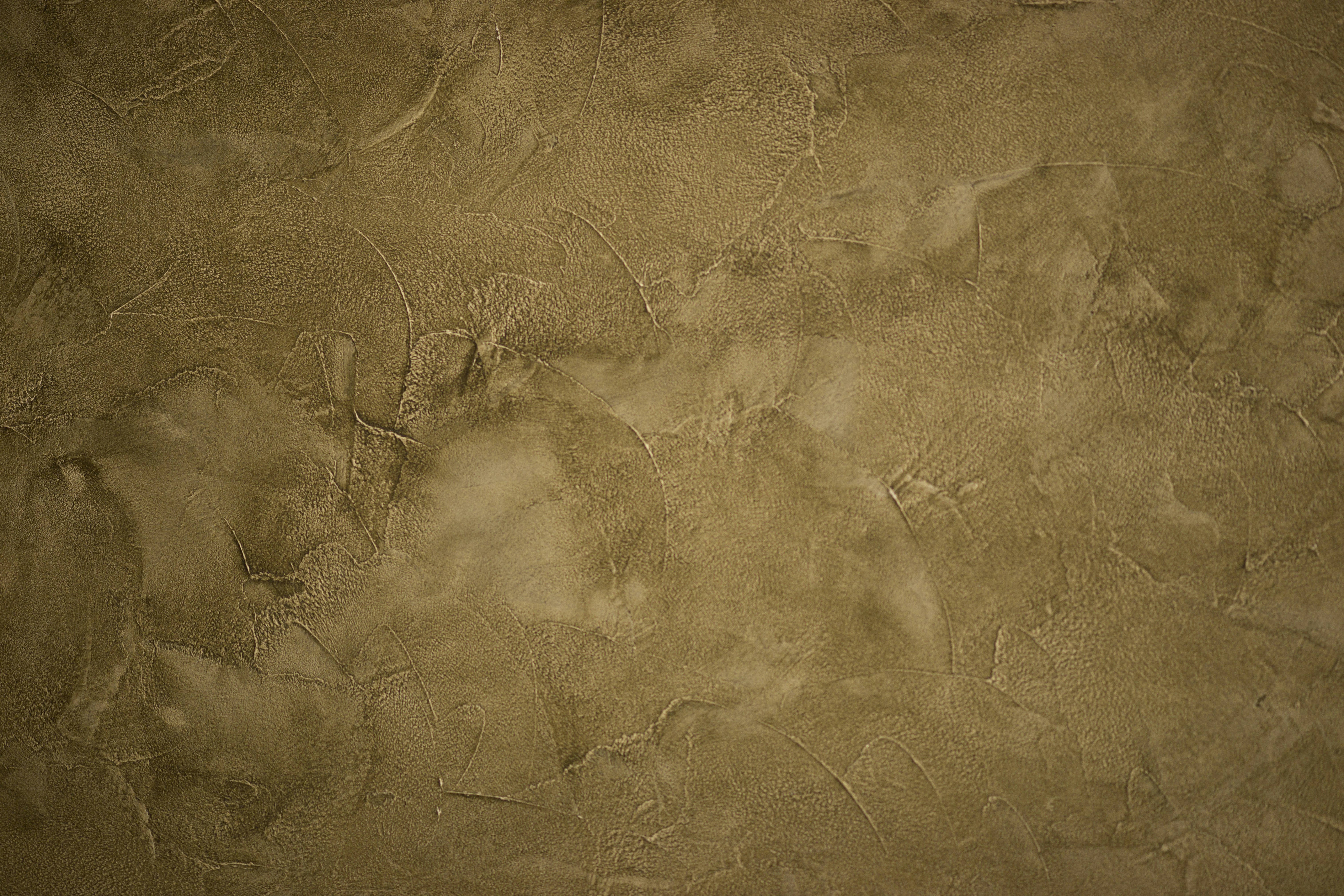 Close-up of a textured surface showcasing earthy tones and intricate patterns, emphasizing the interplay of light and shadow.