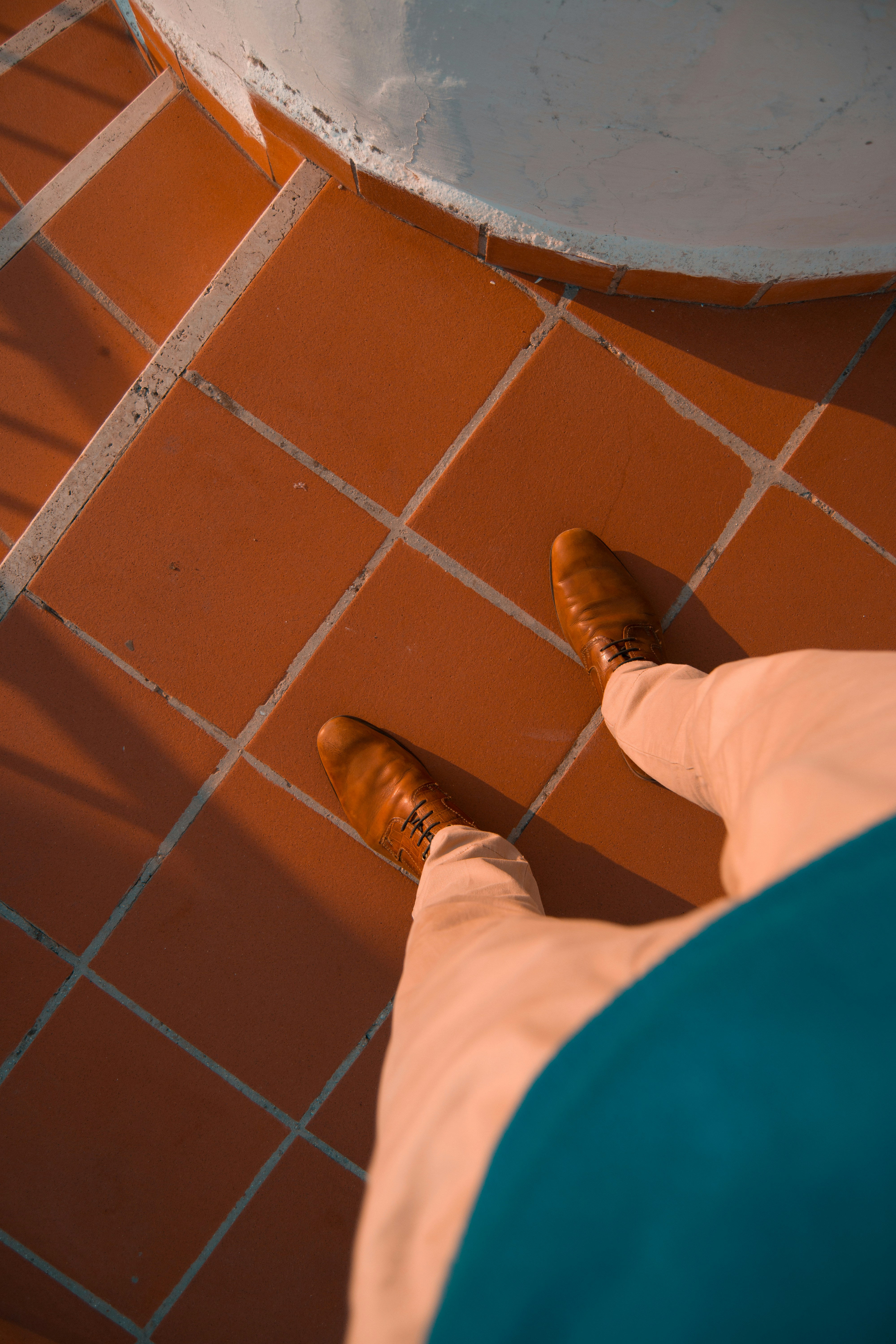 Grounded in Rust: Feet in Leather on Terracotta Tiles