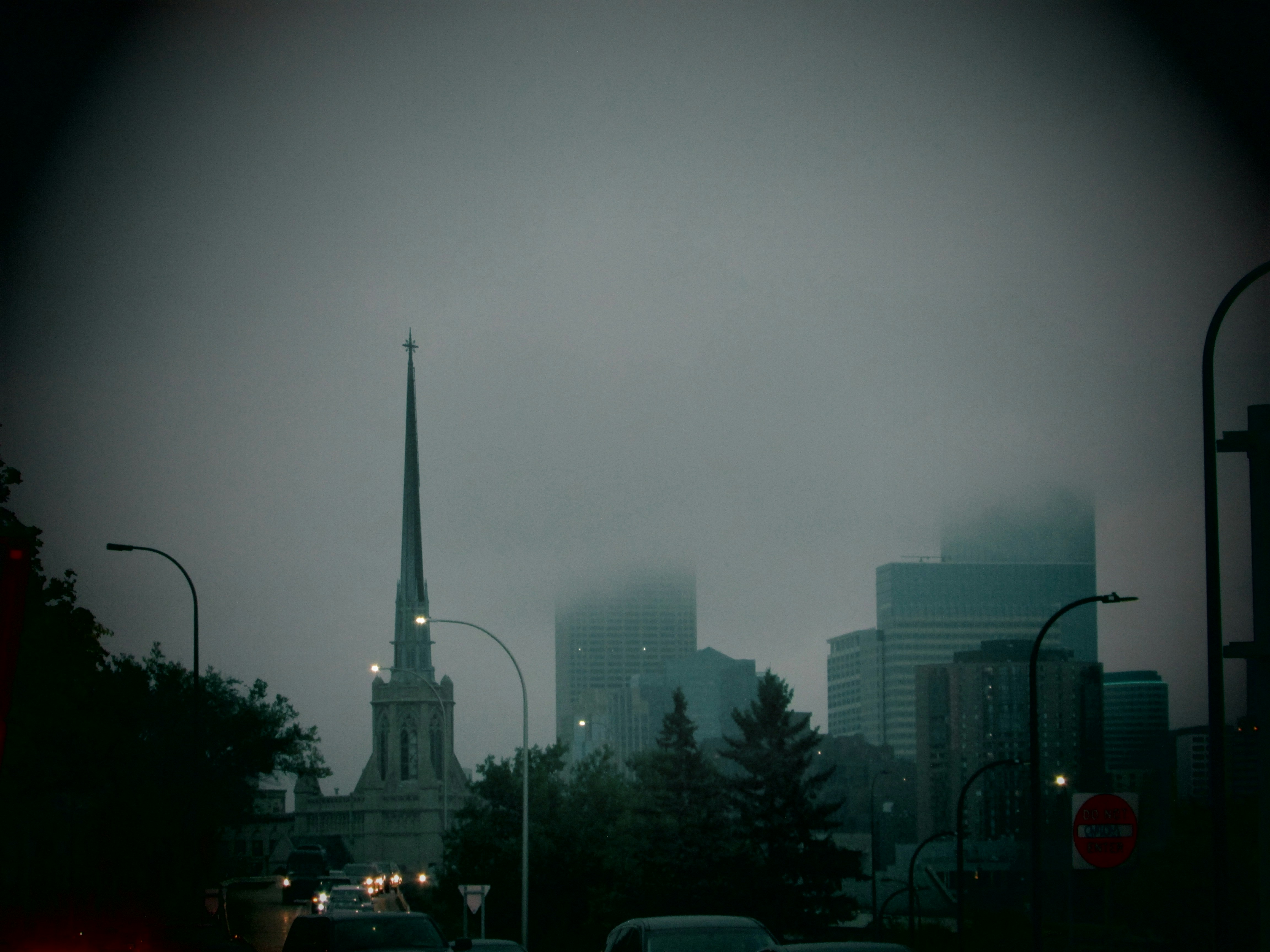 black car on road near high rise buildings during daytime