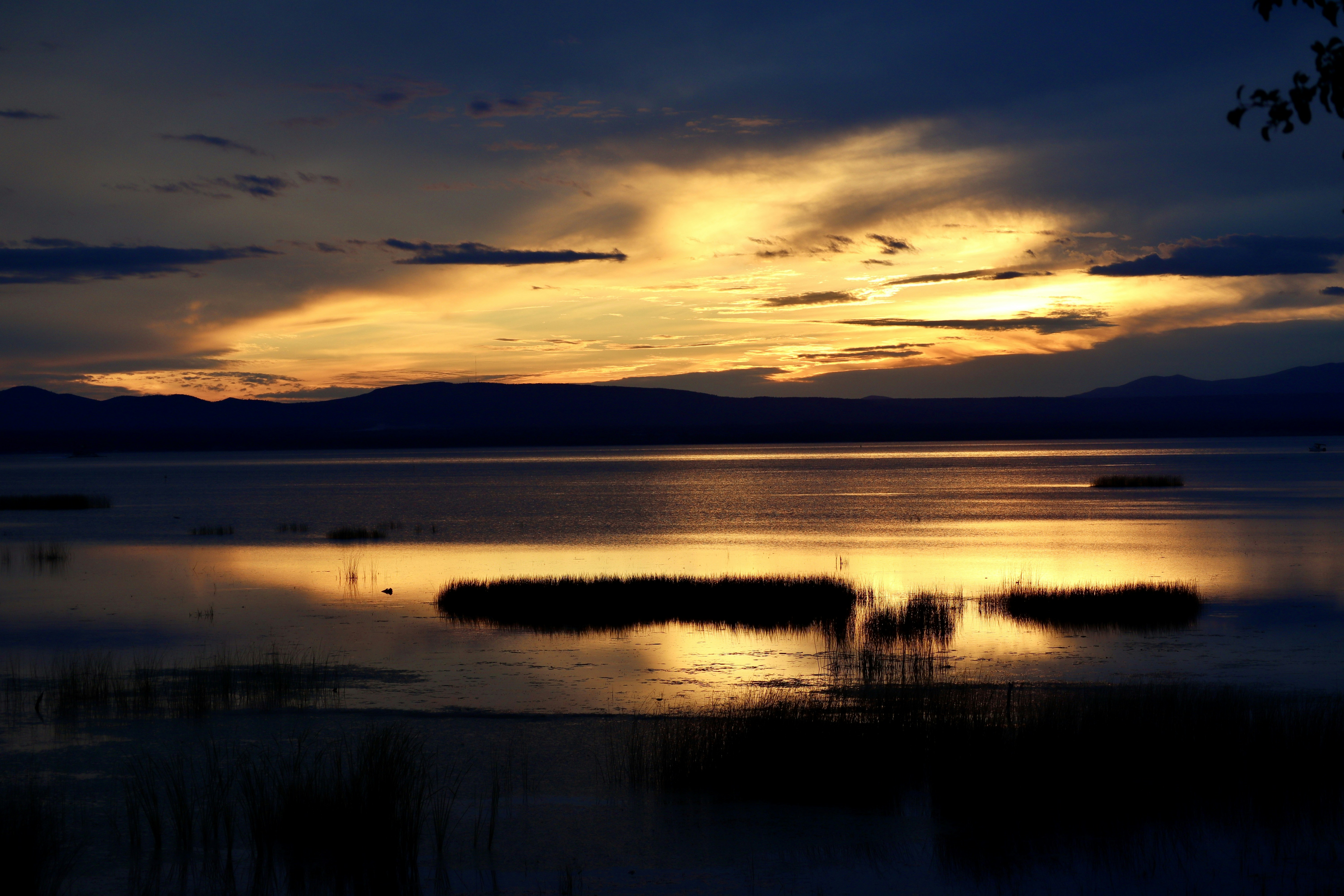 Lake Champlain sunset | calm water under cloudy sky during sunset