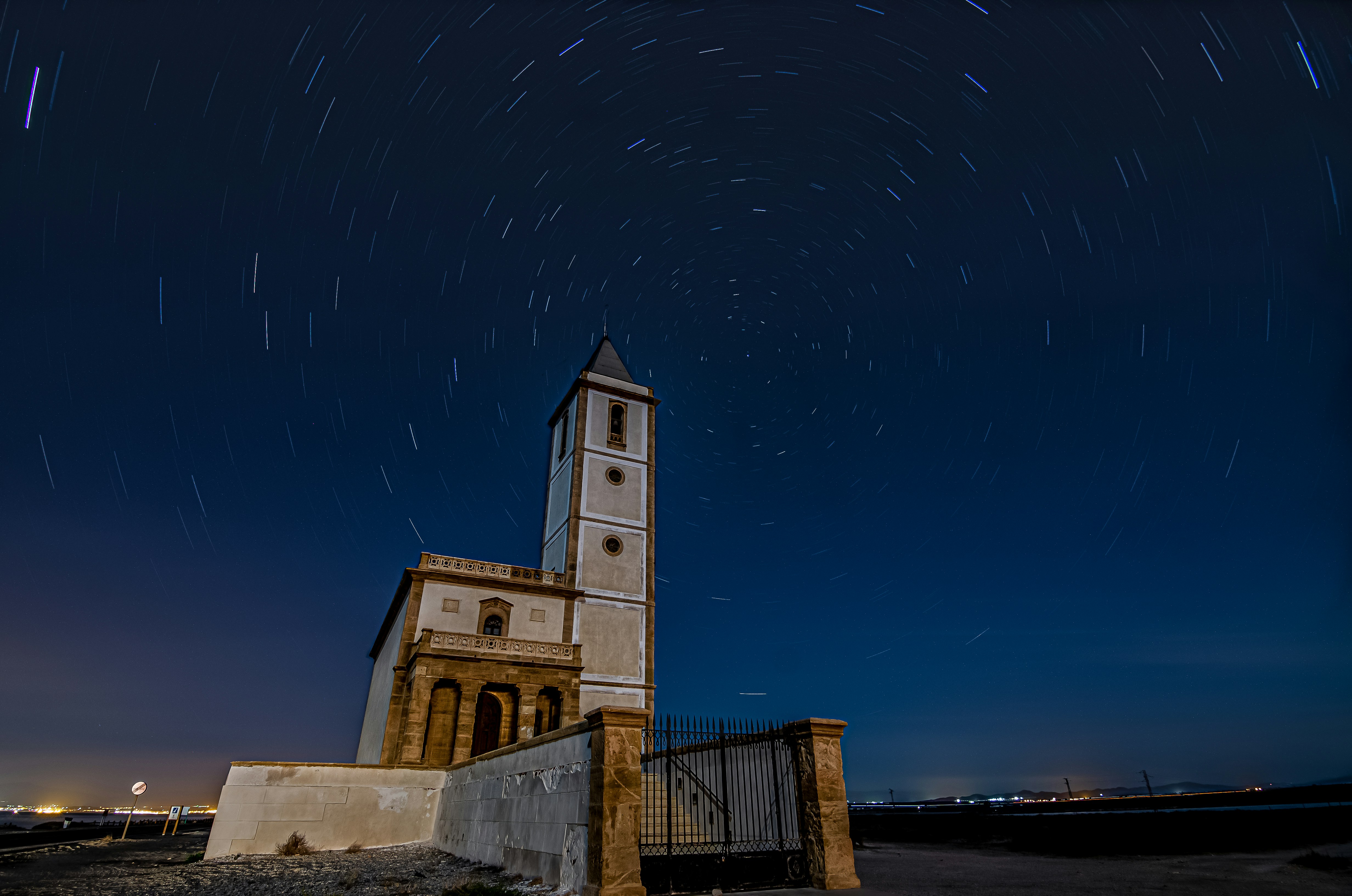 Coastal Bell Tower Beneath a Ring of Stars: A Long-Exposure Night Scene