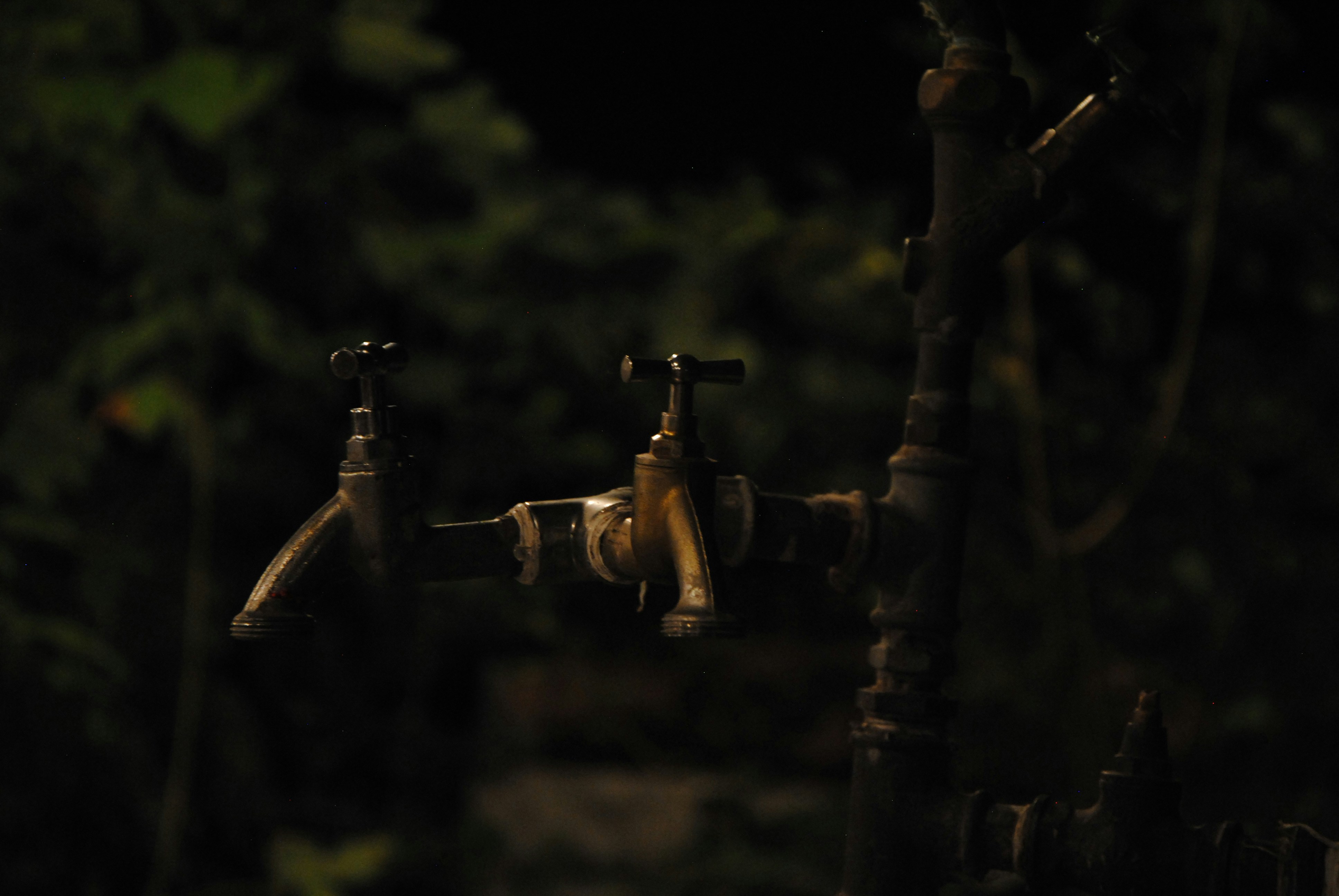 Brass Nightwork: A Quiet Portrait of an Outdoor Faucet
