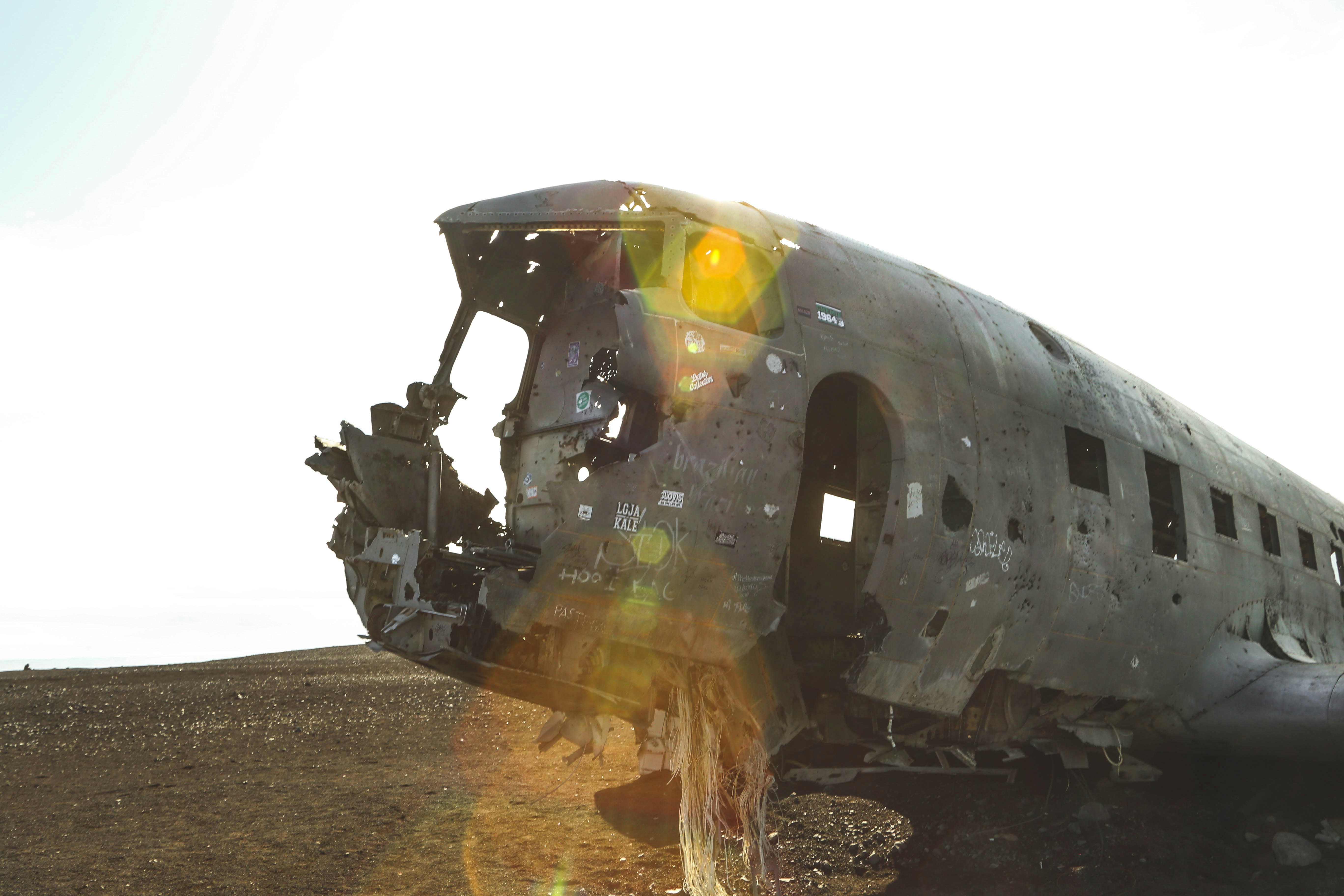 Charred Nose of a Jet Wreck on a Desolate Plain under a Blazing Sun