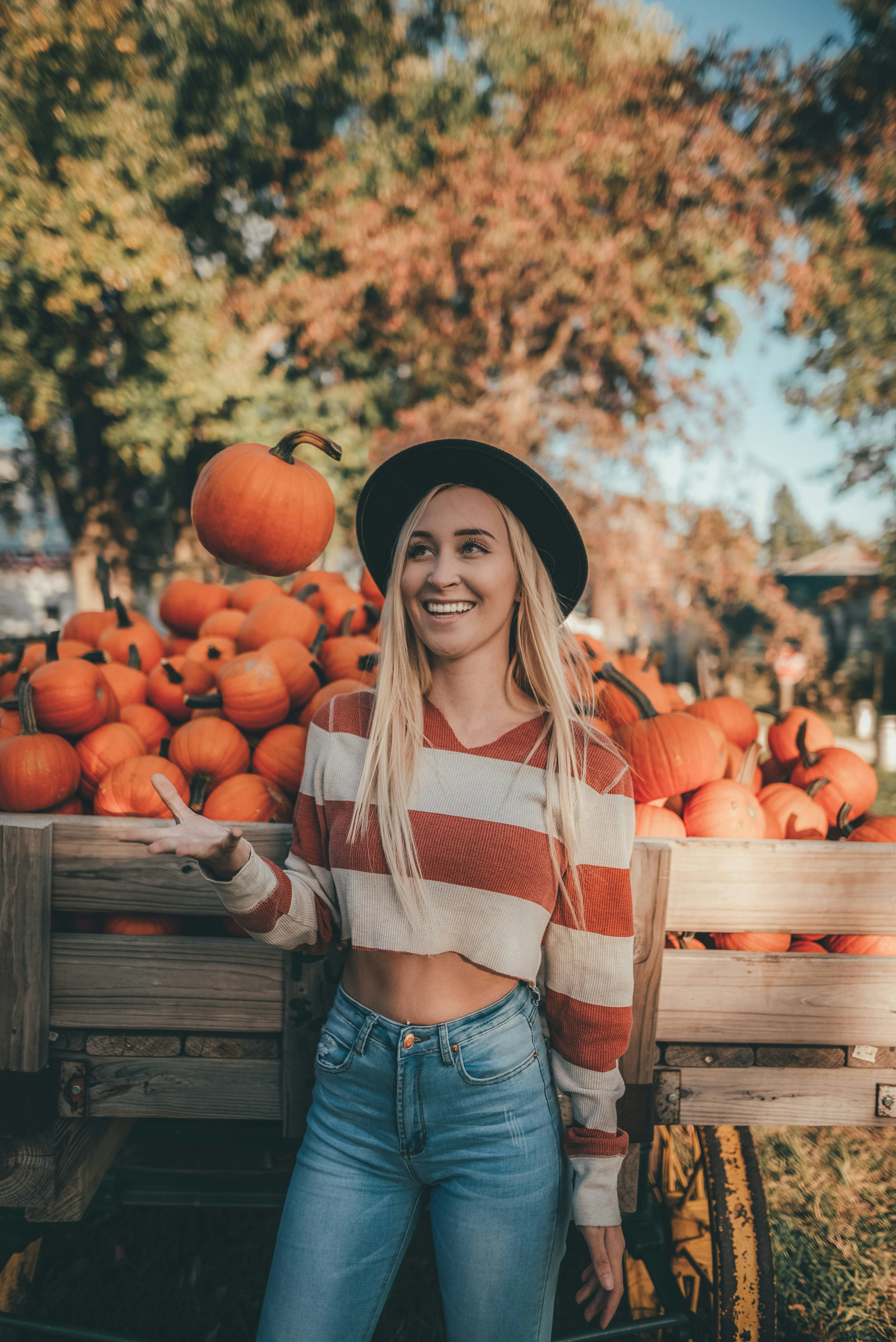 Pumpkin Season Portrait: A Smiling Frame Among Autumn Harvest