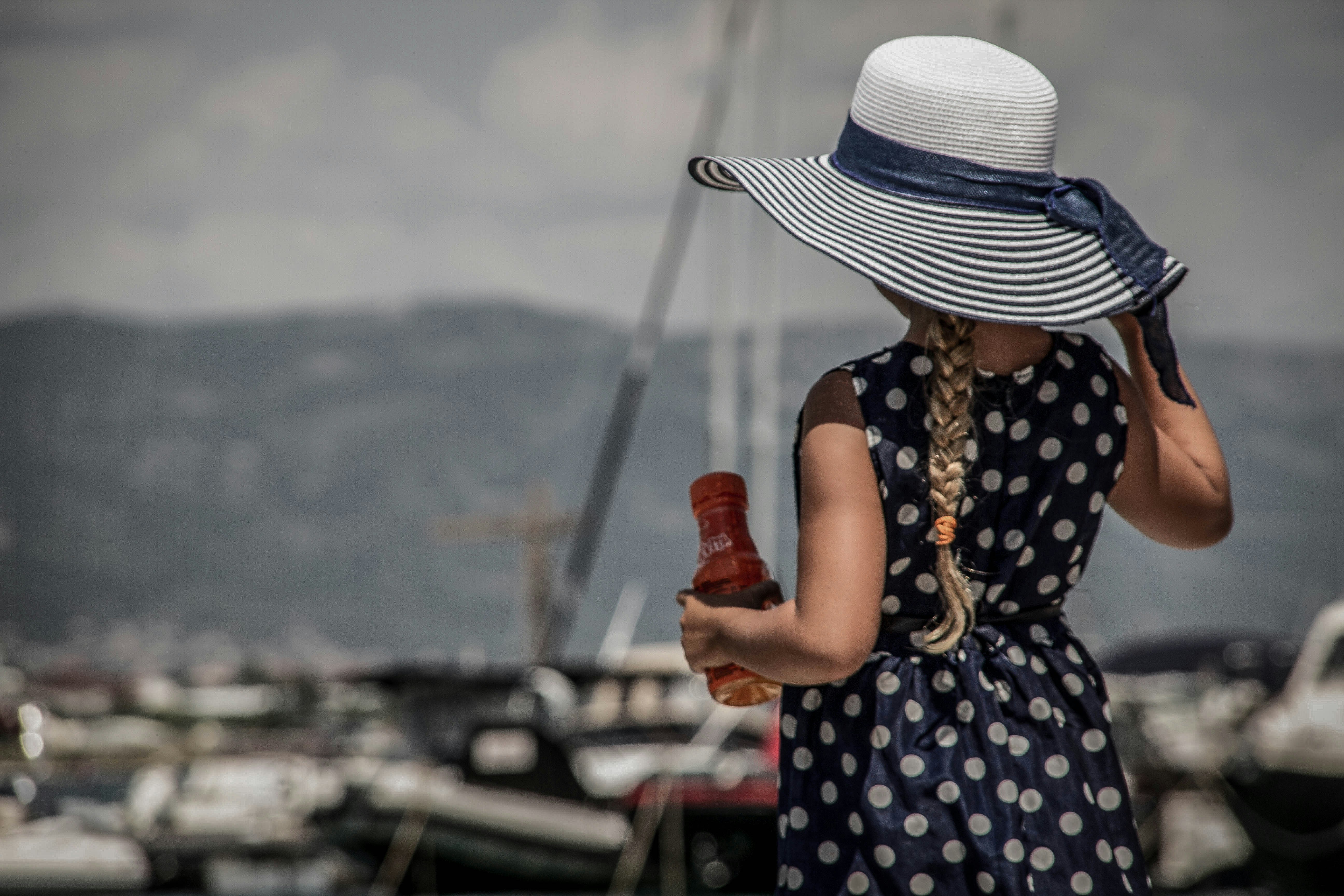 Polka-Dot Portrait at the Harbor: A Striped-Hat Moment