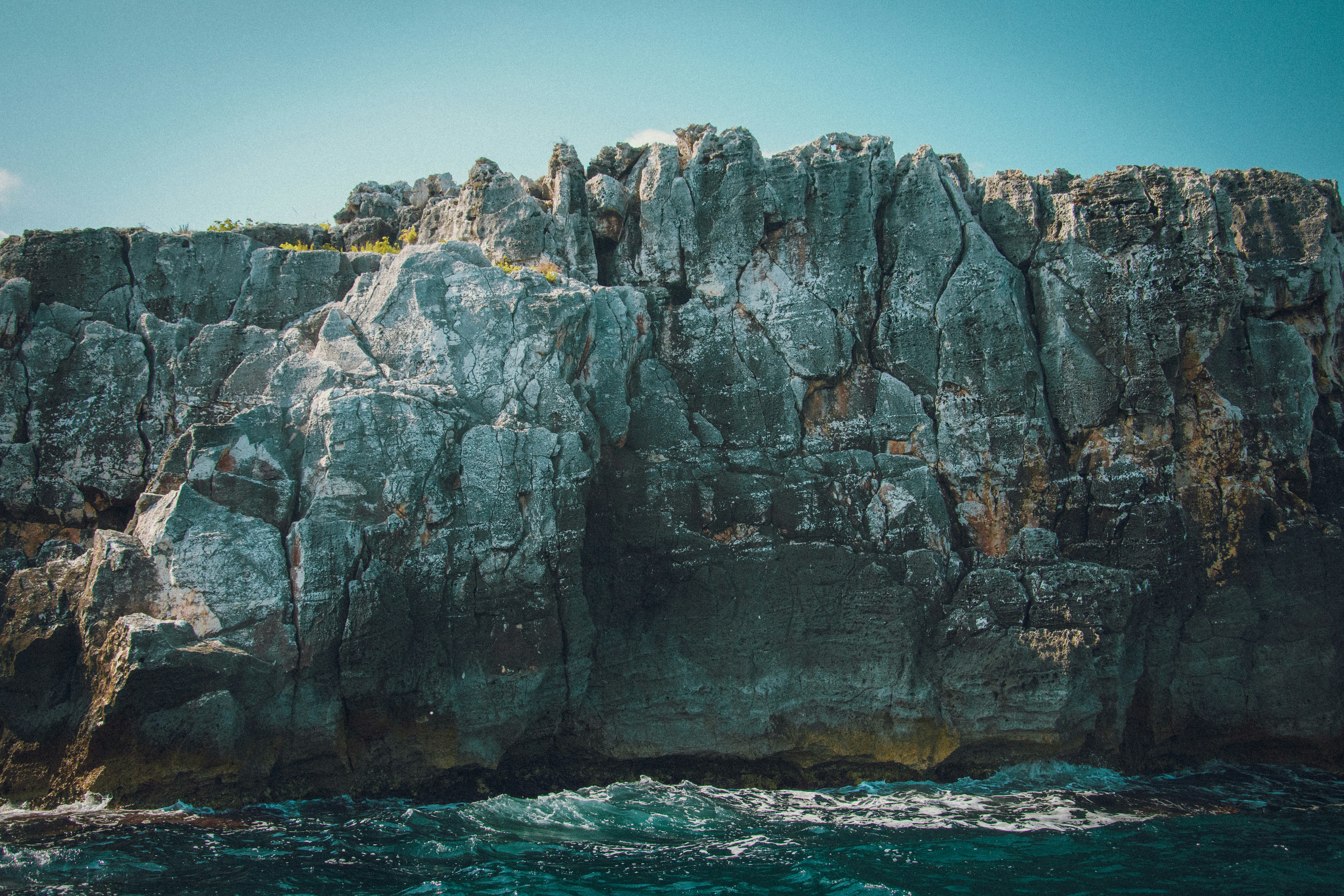 Taken during a boat trip in south of Italy | gray rock formation on body of water during daytime