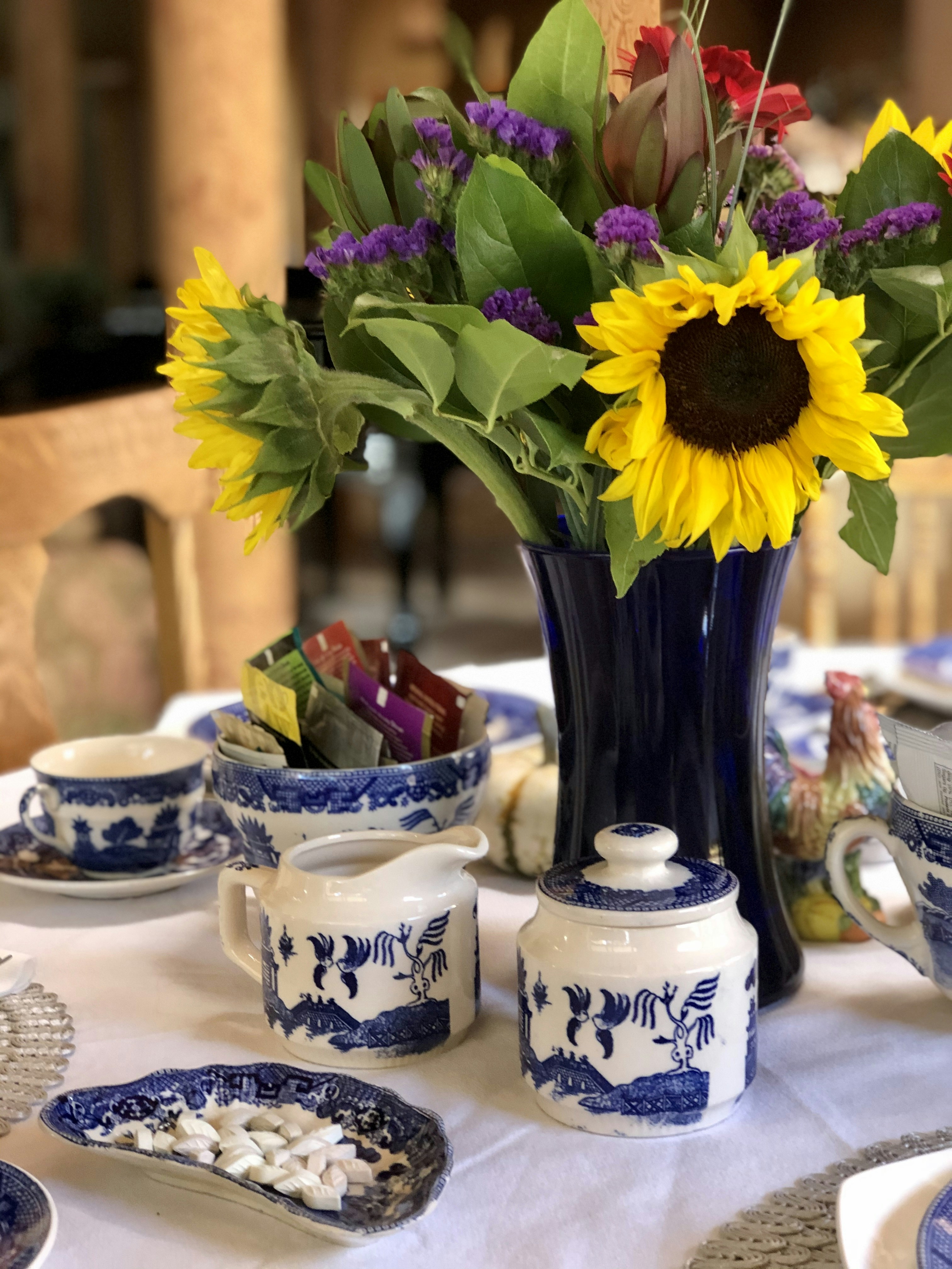 Sunflowers in a cobalt vase: a blue-and-white tea-table vignette