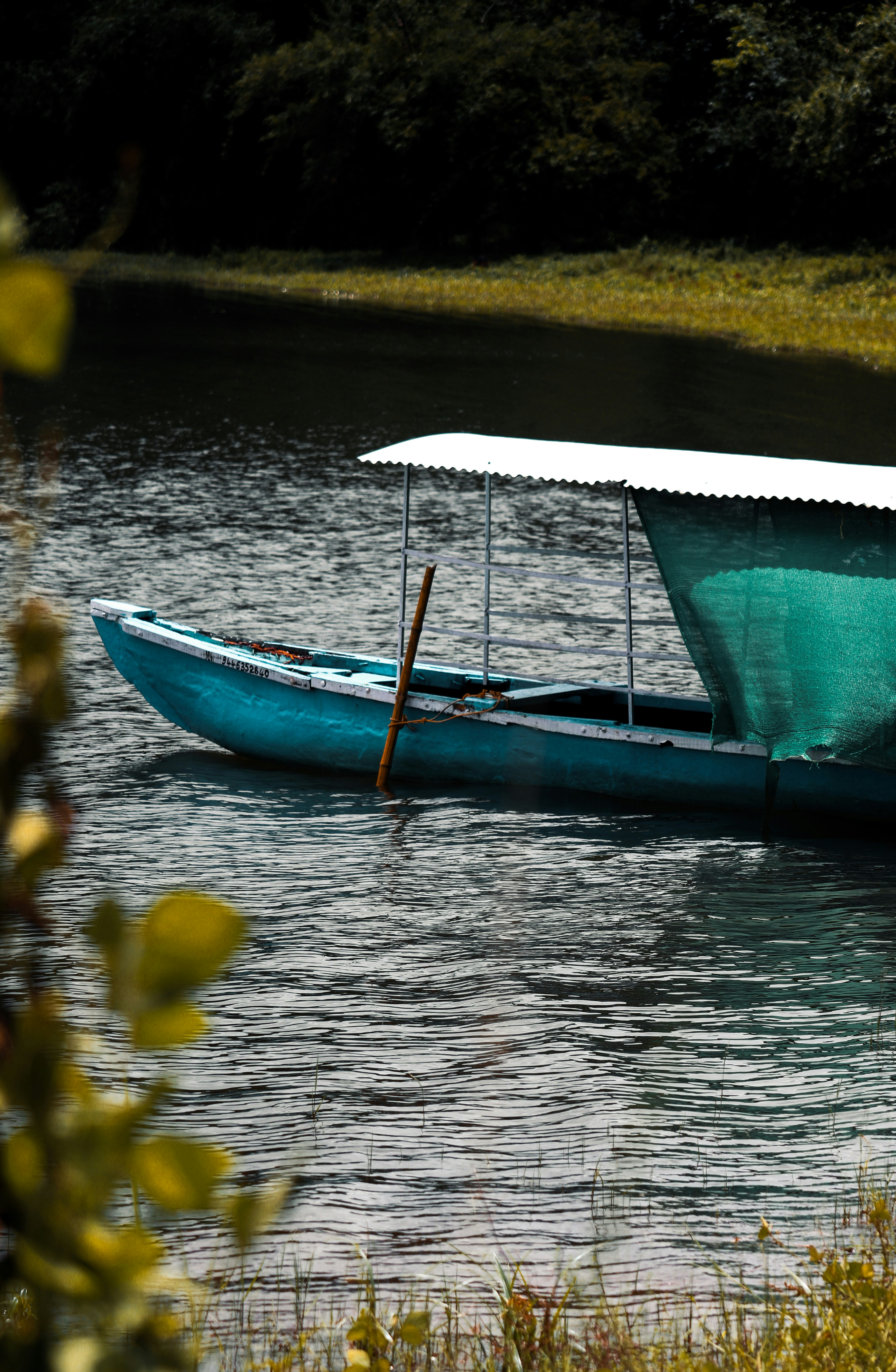 Azure Rowboat Under a White Canopy on a Quiet Lake
