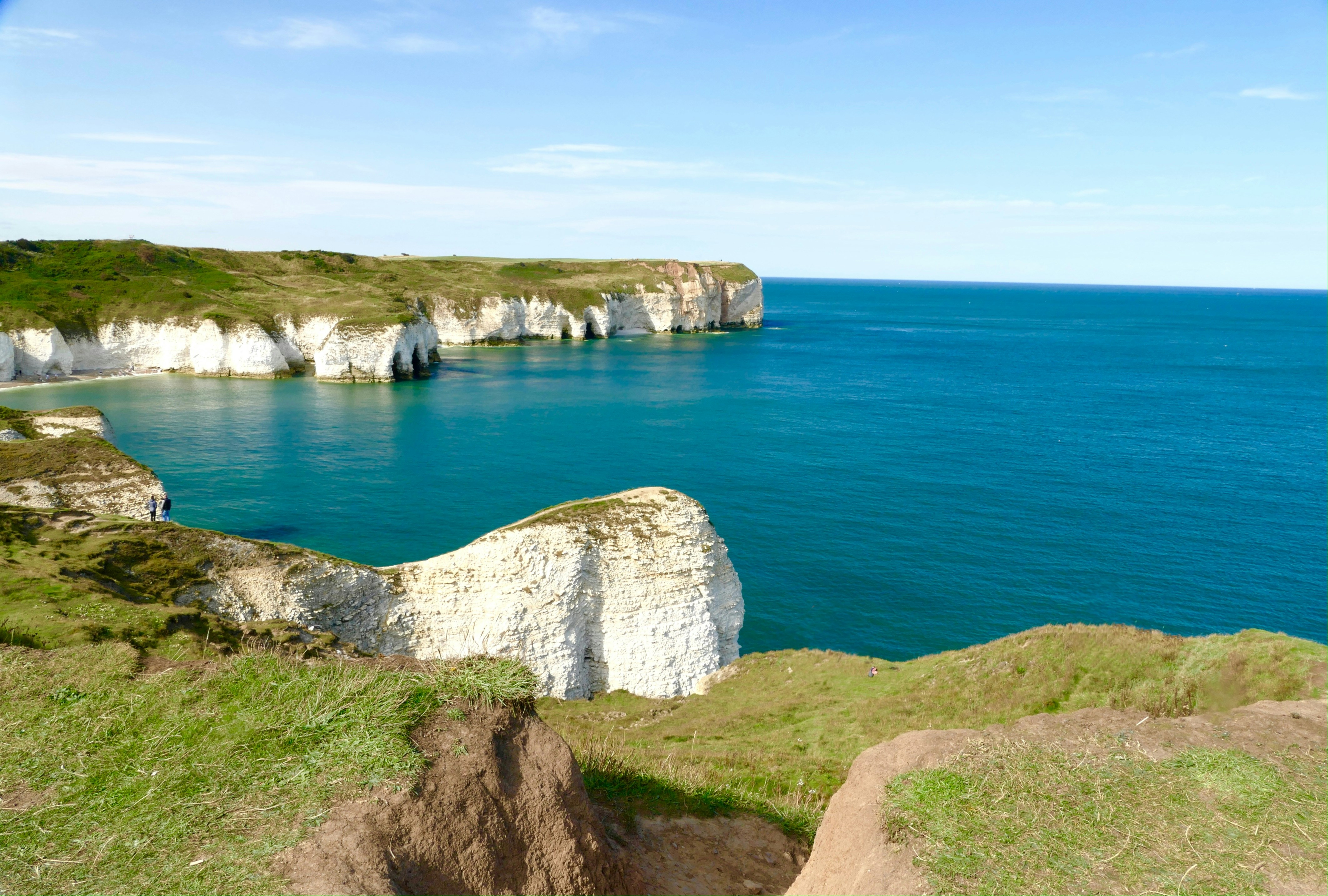 White and brown rock formation near blue sea under blue sky during ...