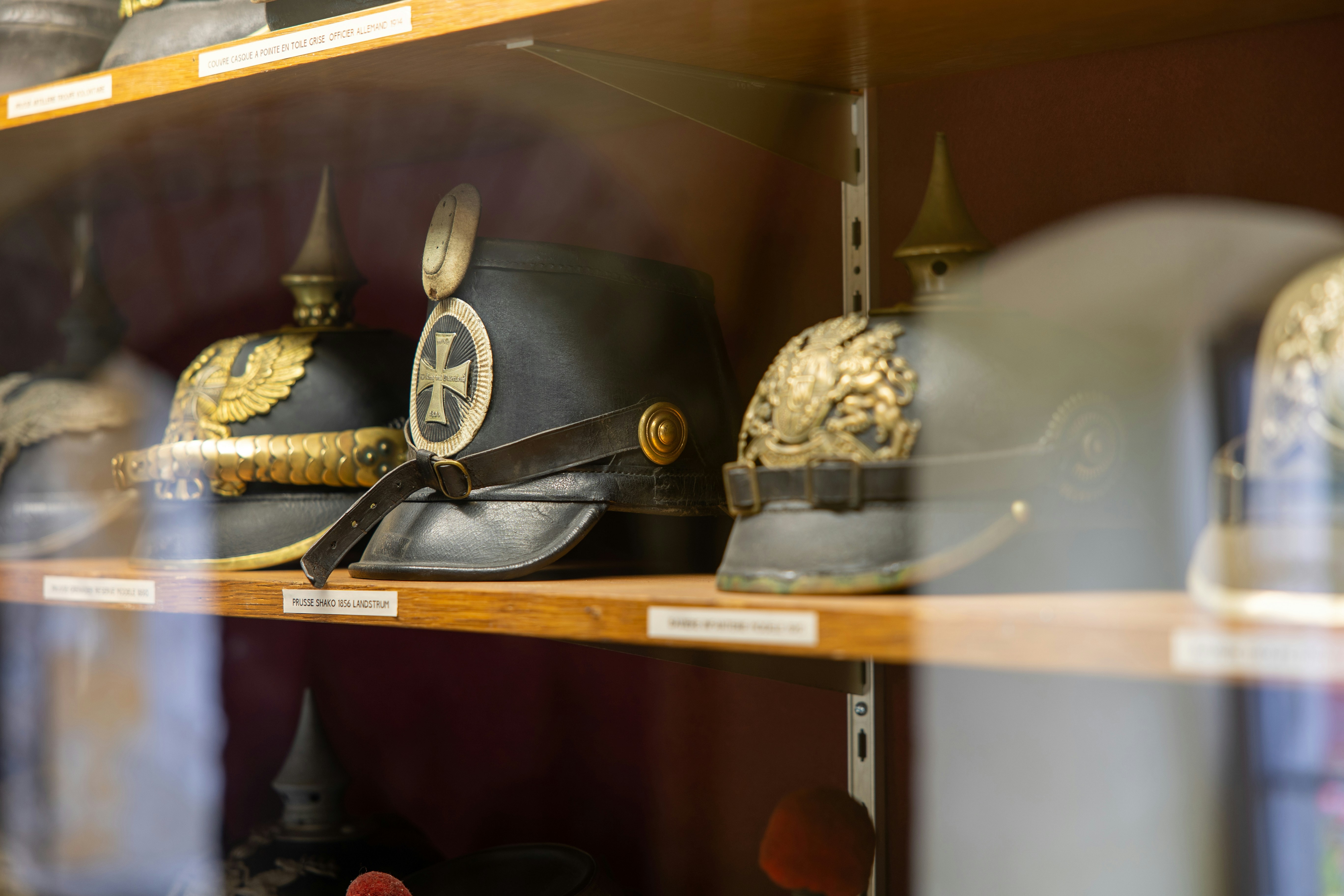 Ceremonial Caps in Quiet Light: A Glass-Case Portrait