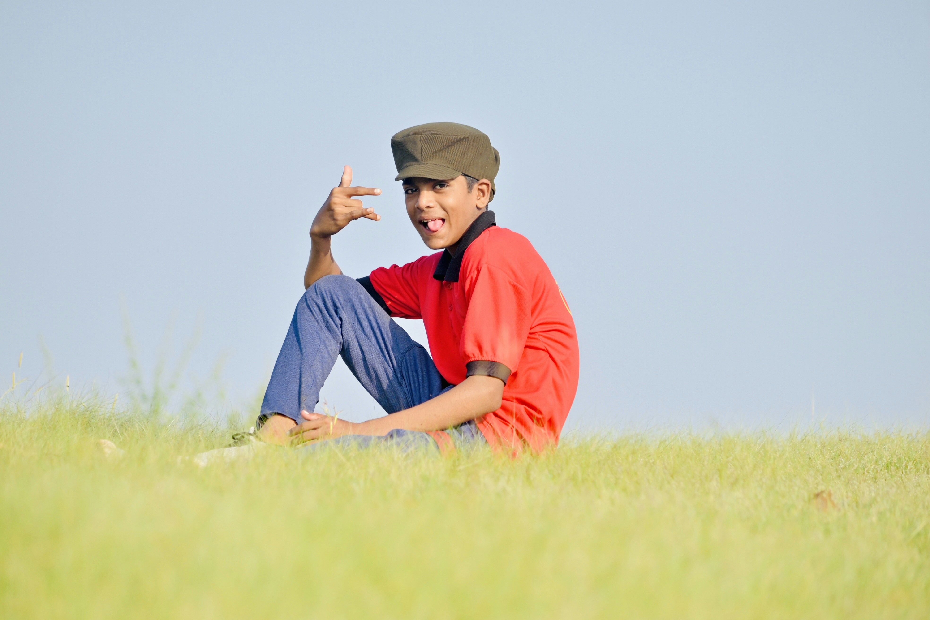Girl on a Hill: Red Shirt, Blue Jeans, and Sunlit Grass