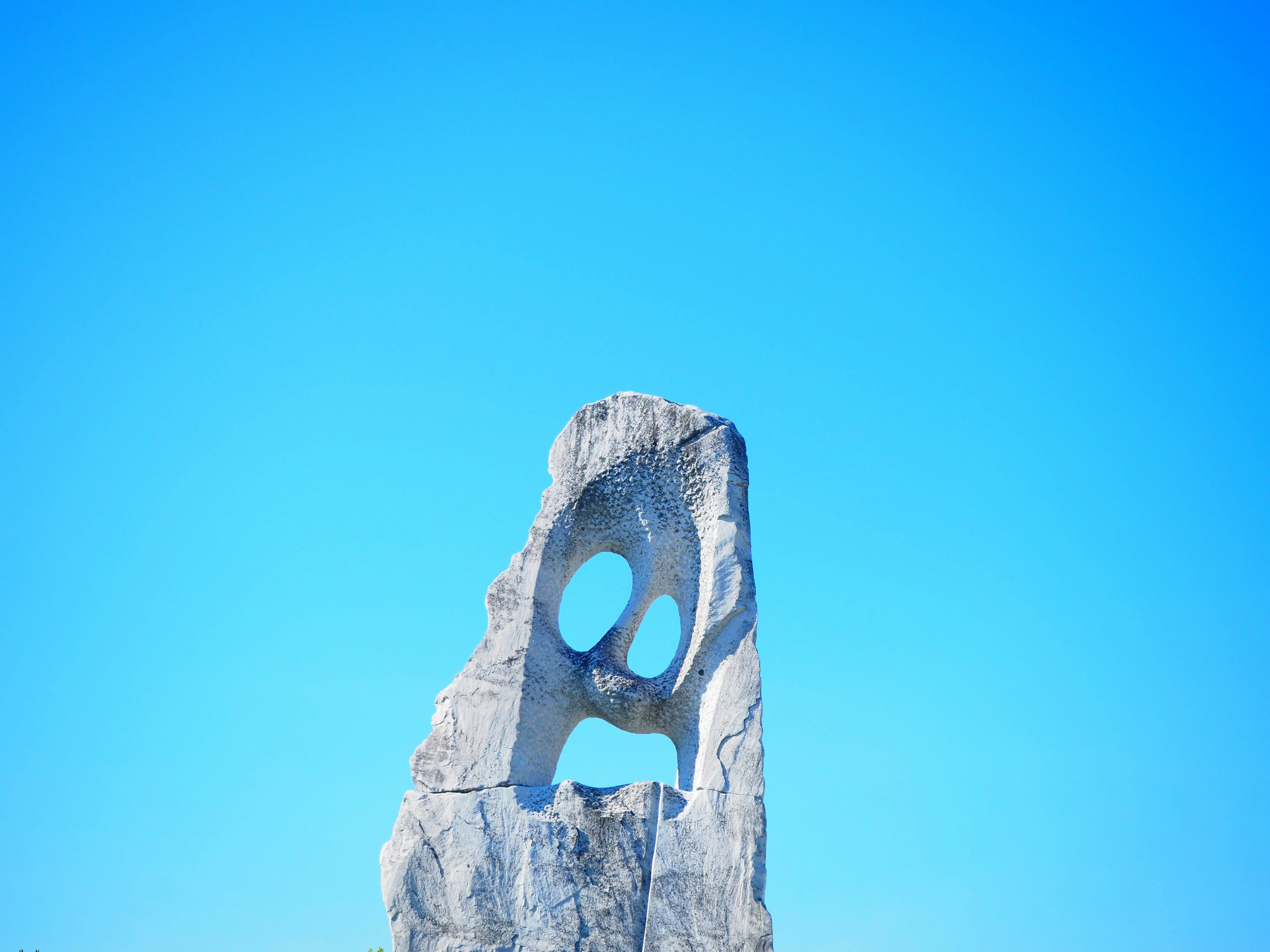 Gray concrete human face carved statue photo – Free Blue Image on Unsplash