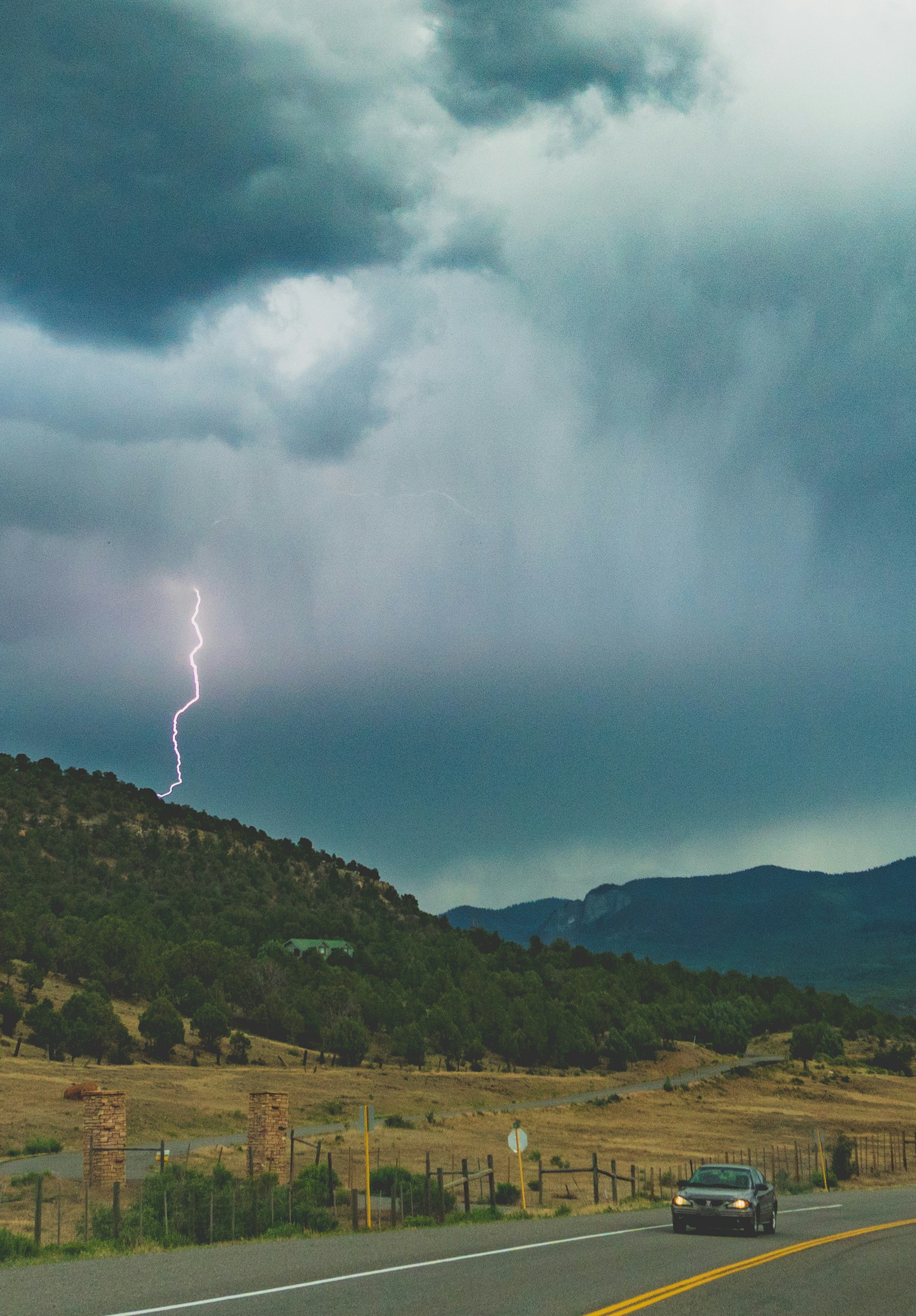 Storm Lightning Over the Rolling Hills and Road