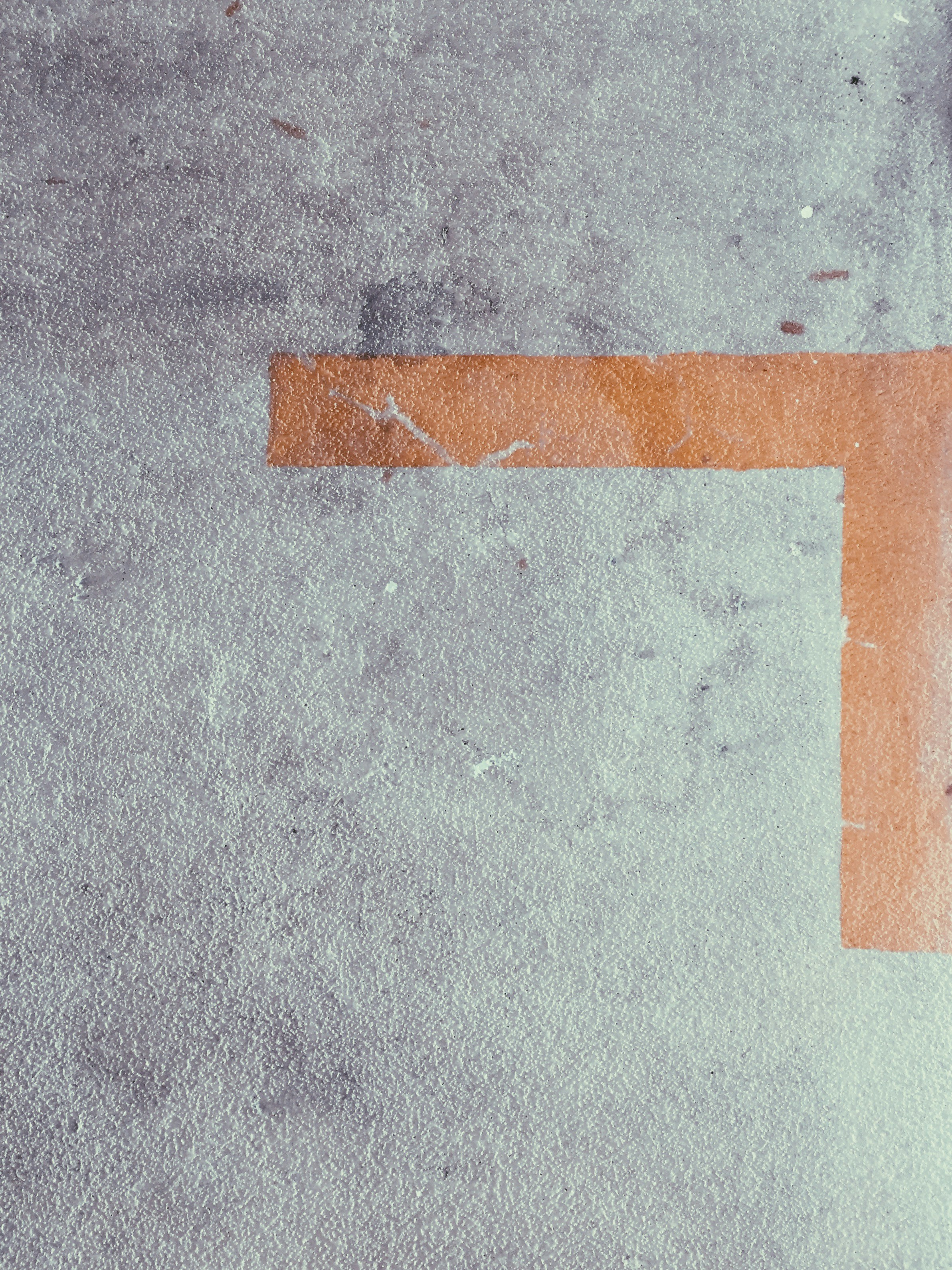 Edge Geometry: An Orange L-Shaped Accent on a Frosted Surface