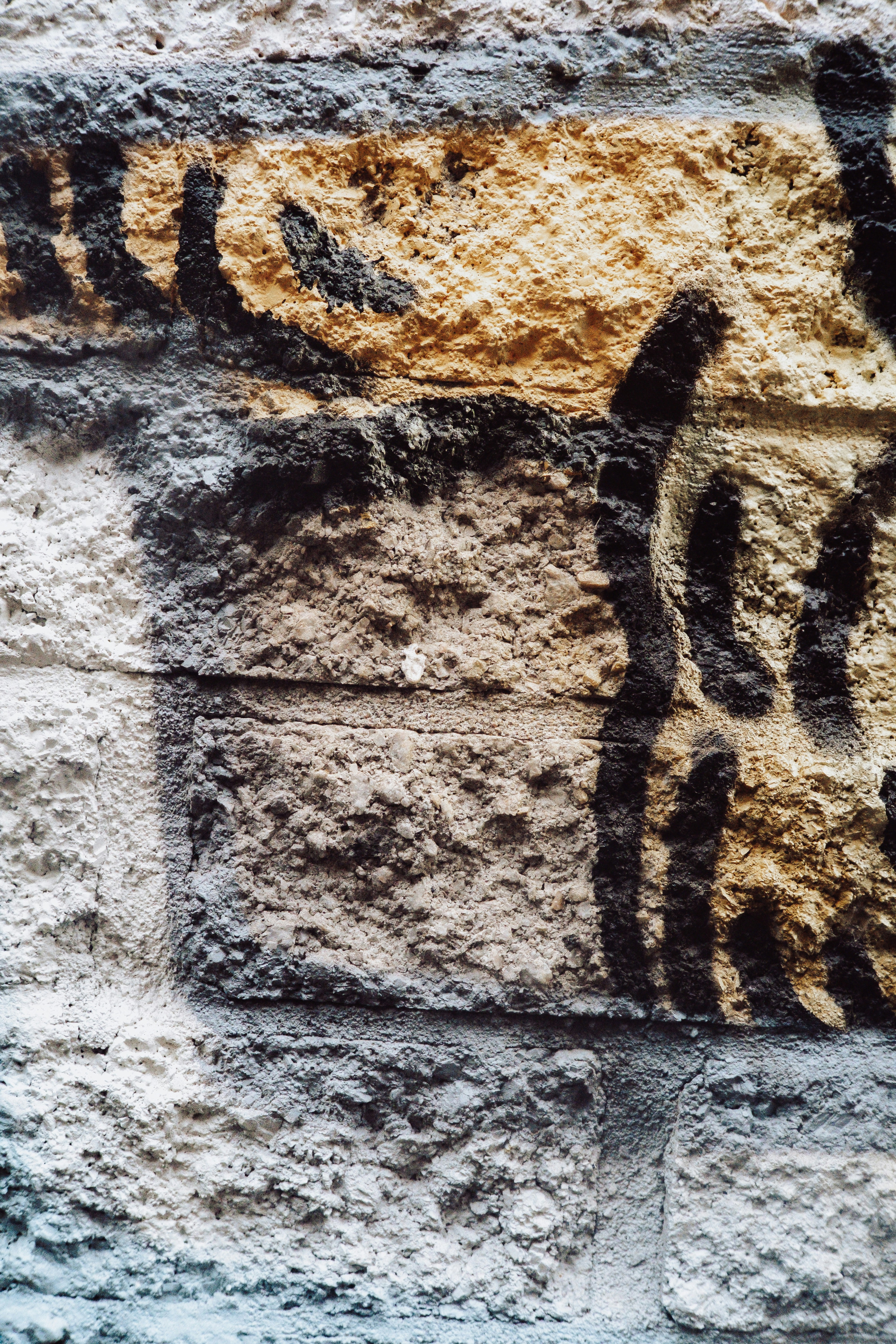 Ancient Brickwall Graffiti: Weathered texture meeting bold black strokes