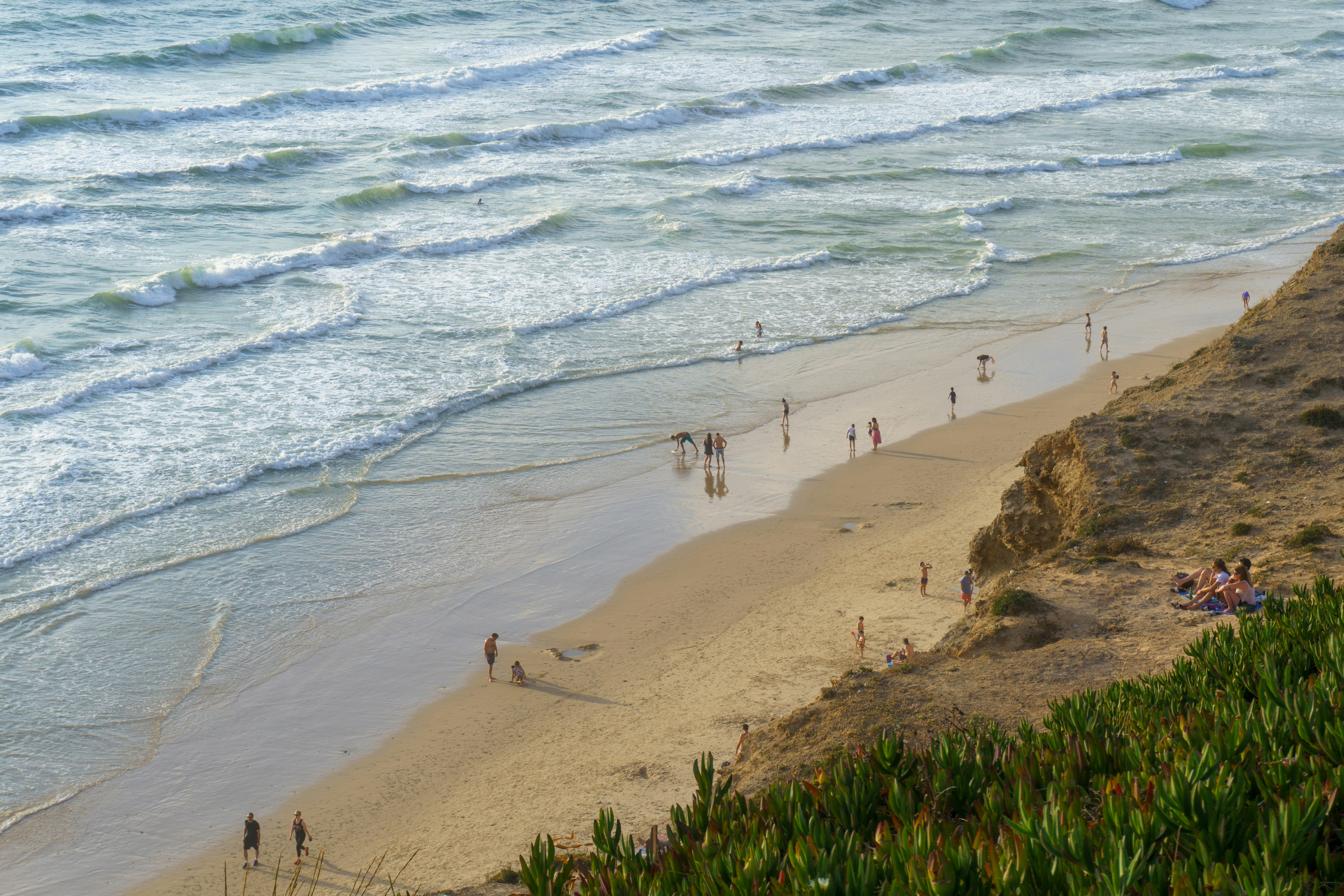 Footprints and Foam: A Cliff-Fringed Beach Scene