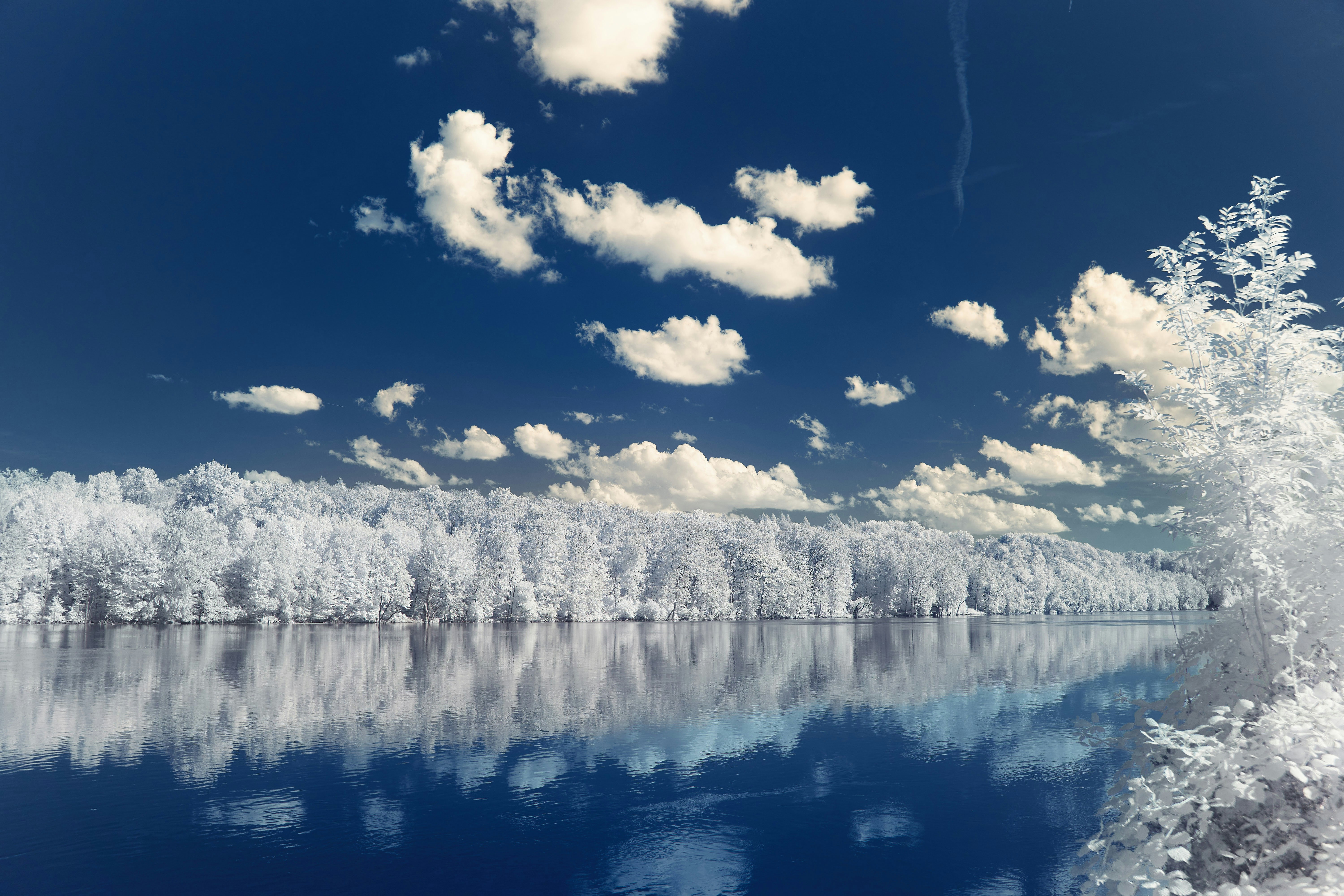 White snow on blue body of water under blue sky during daytime photo ...