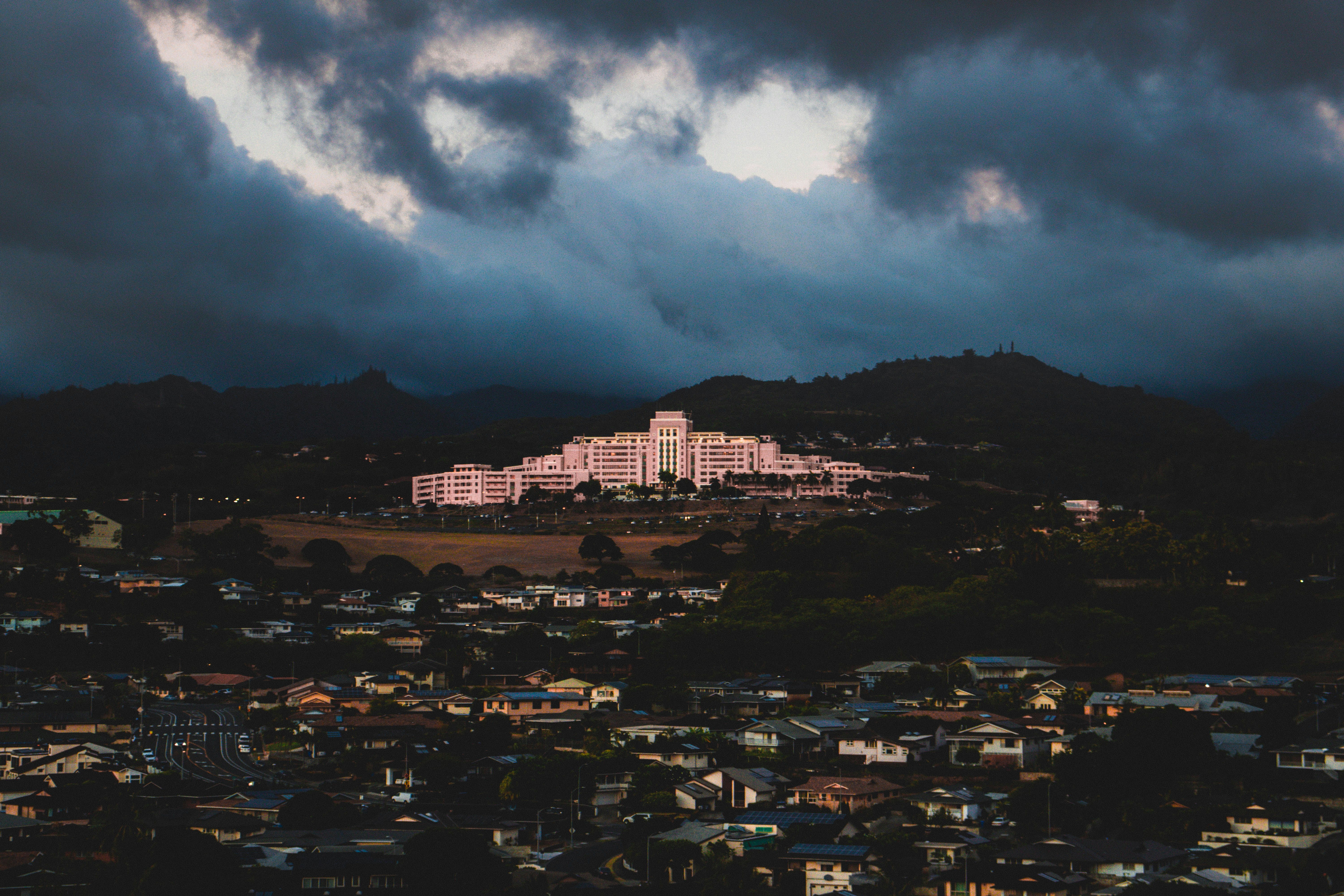 Hilltop Glow Against Tempest Skies