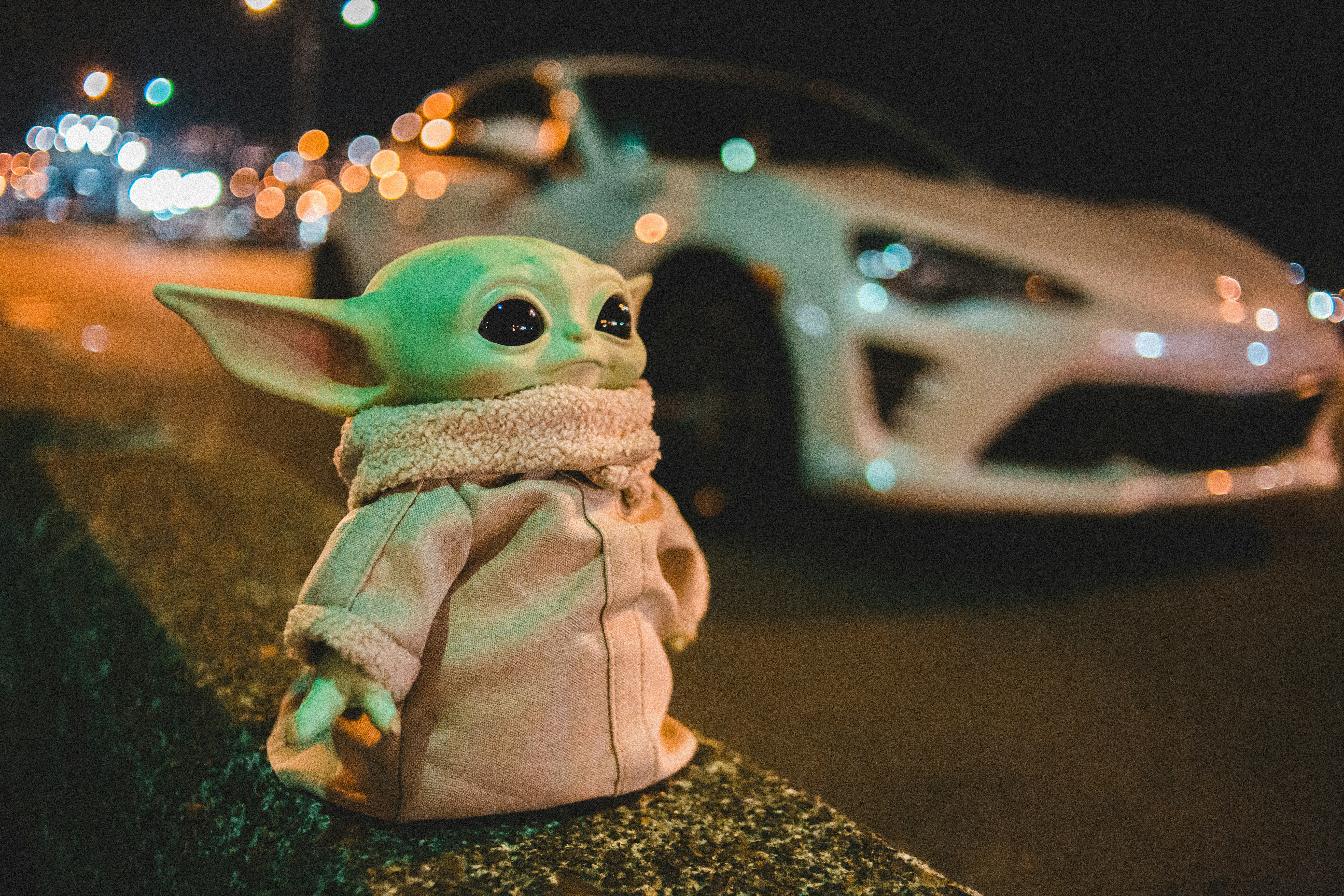 Grogu Amid the City Glow: A Tiny Hero on Night Street