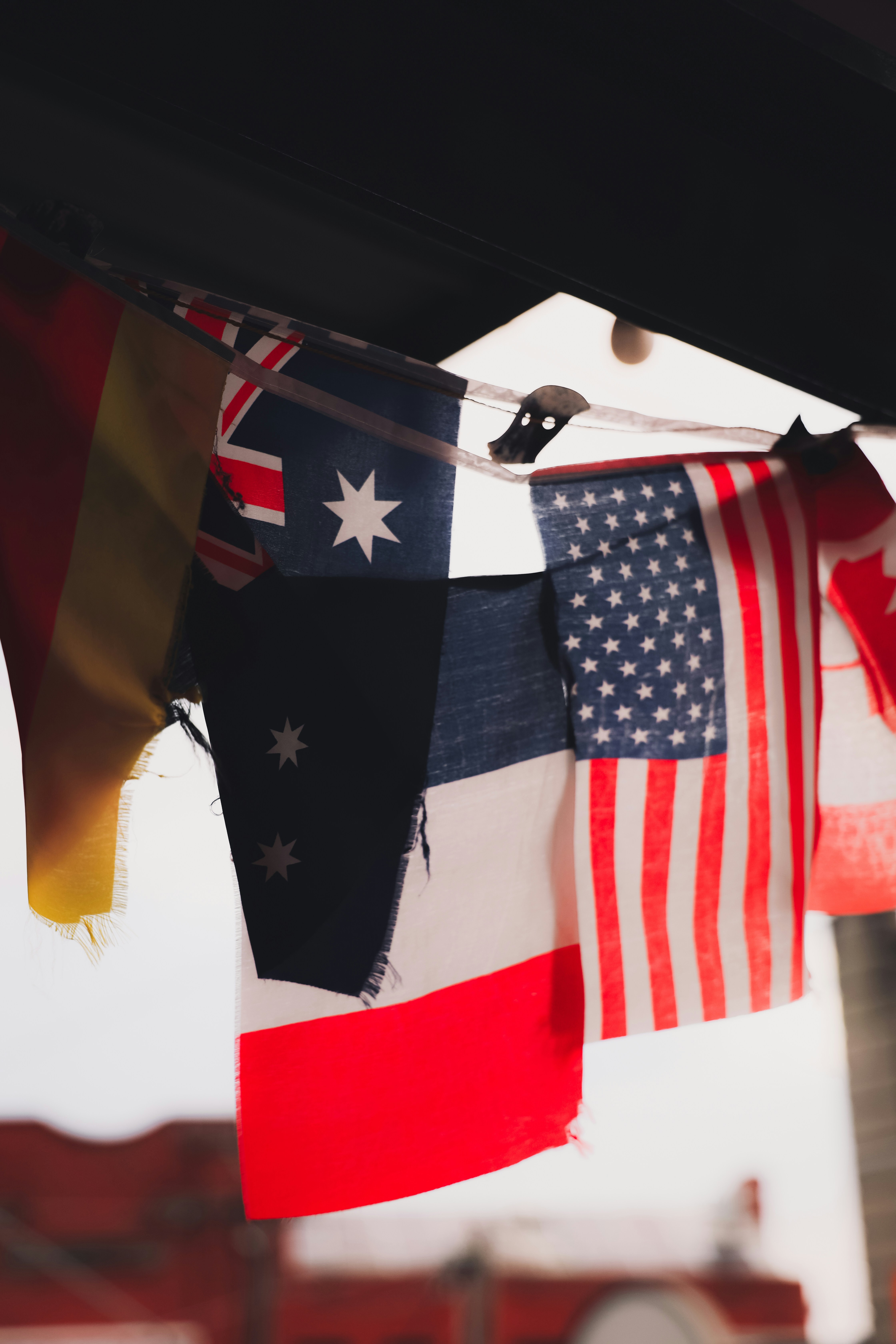 Draped Flags Under Soft Light: Colors Converge Along the Line