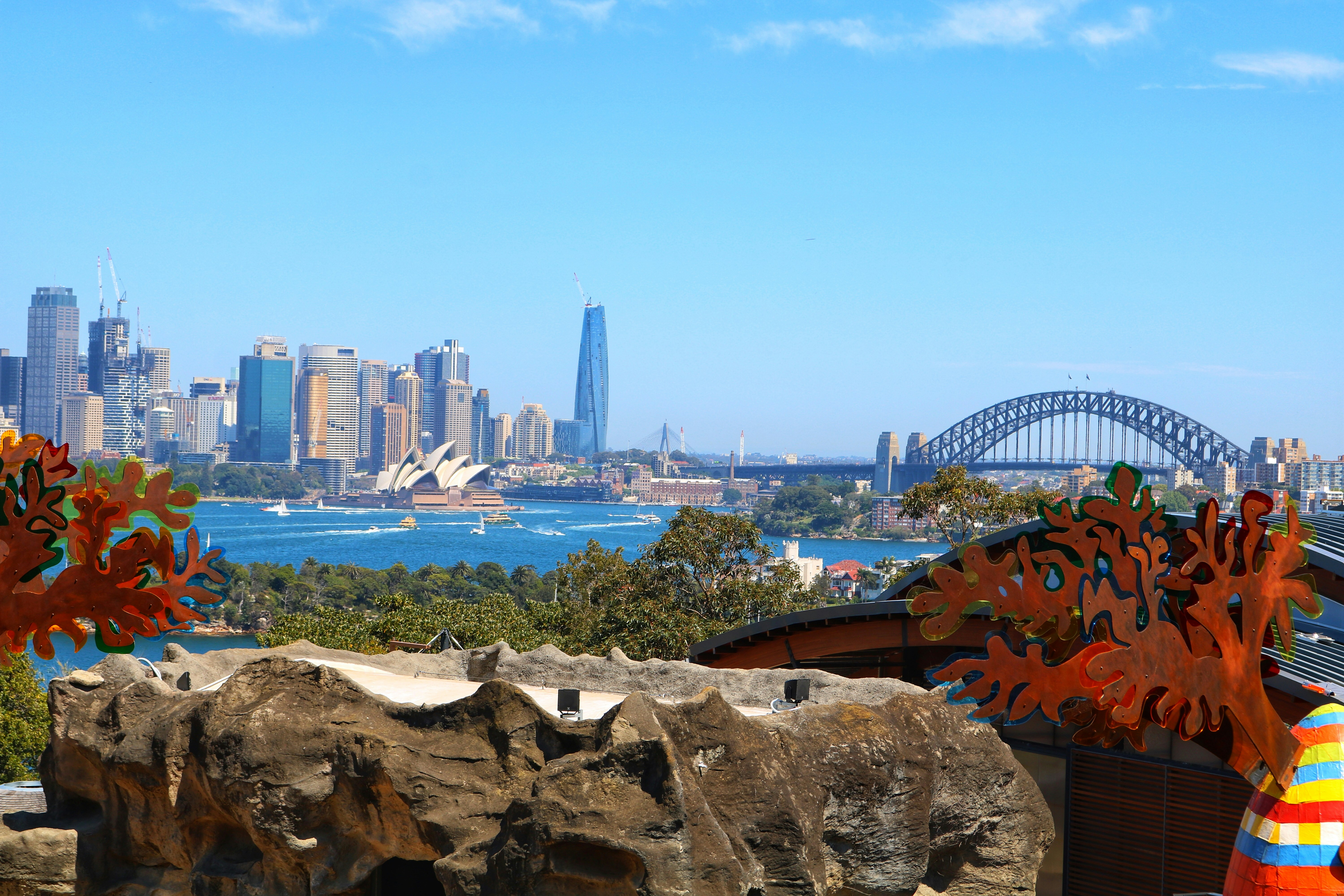 Azure Frontiers: Opera House, Harbour Bridge, and Weathered Rocks