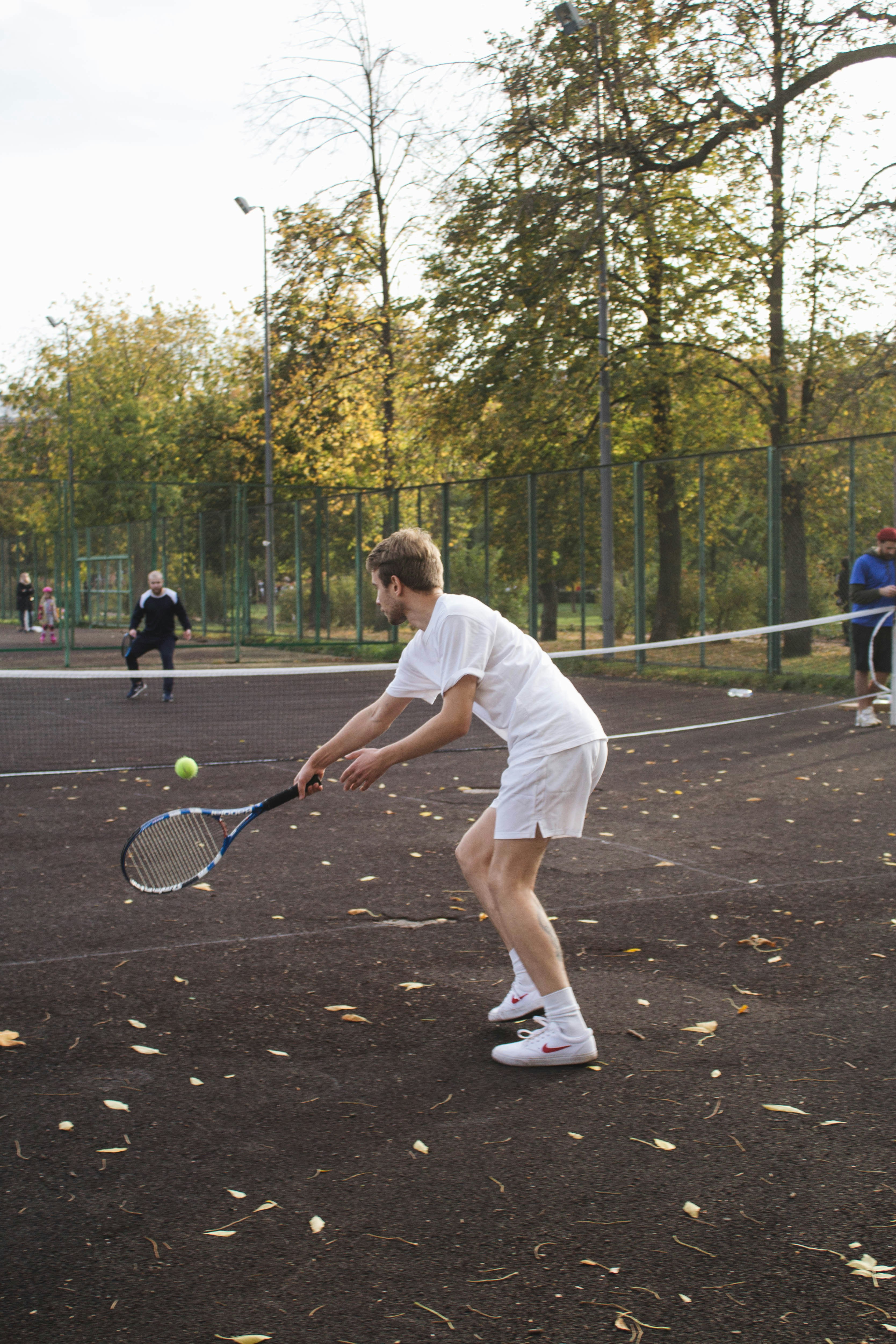 Man in white t-shirt and white shorts holding tennis racket photo ...