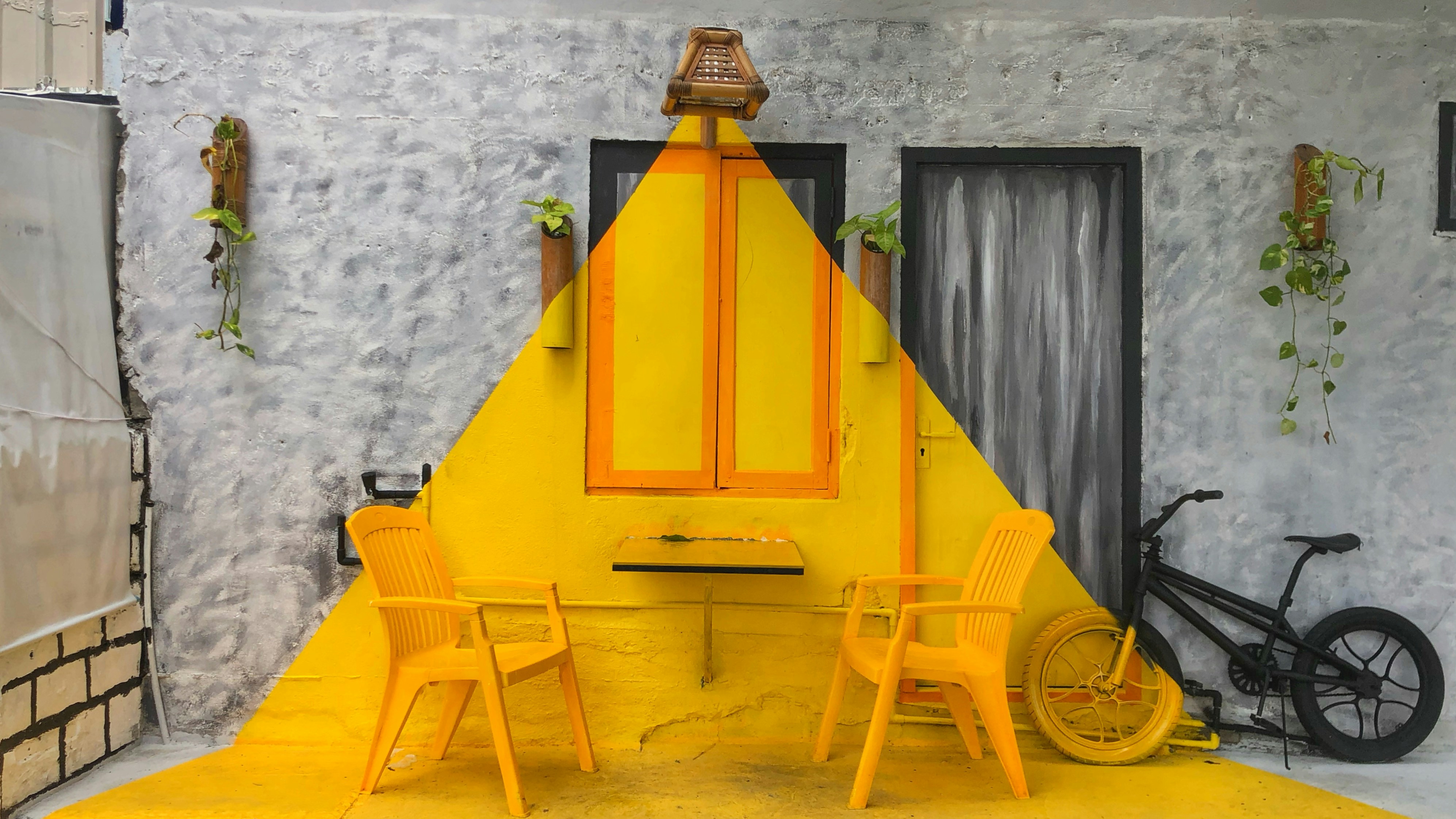 Sunlit Yellow Triangle Courtyard: A Colorful Oasis