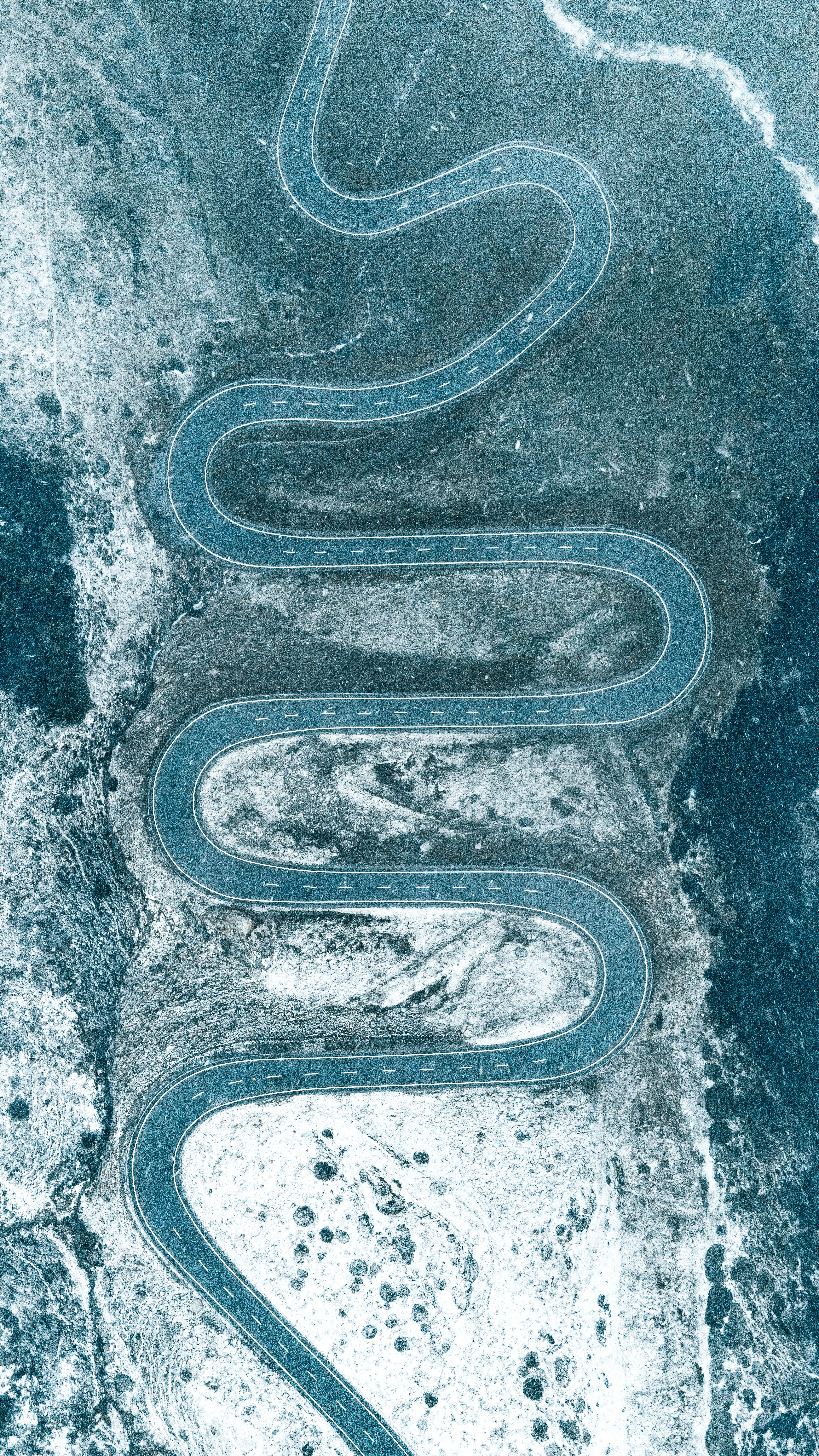 Snow-veined Switchbacks Carving a Frozen Desert