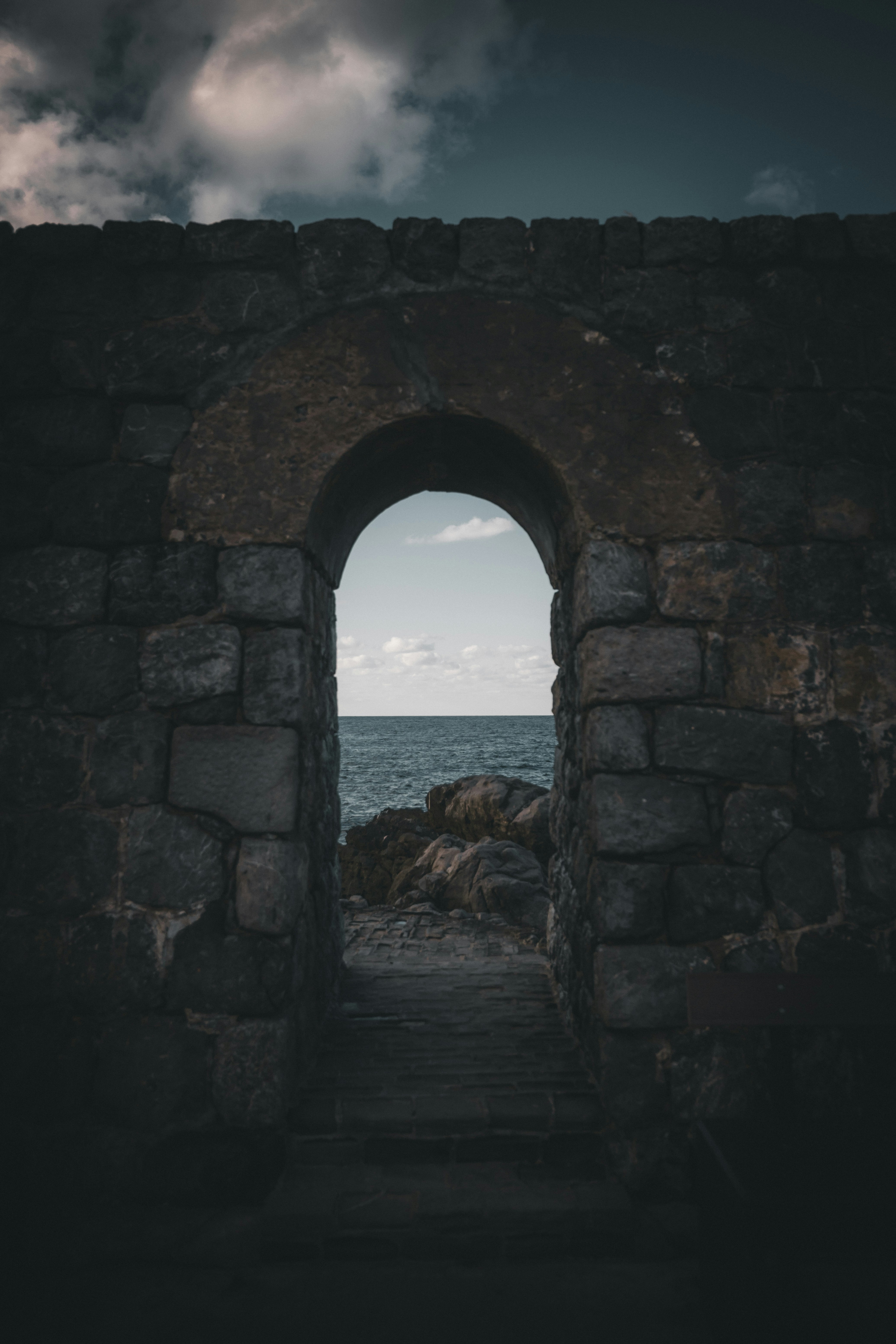 Archway to the Sea: A Weathered Gate Framing the Quiet Horizon