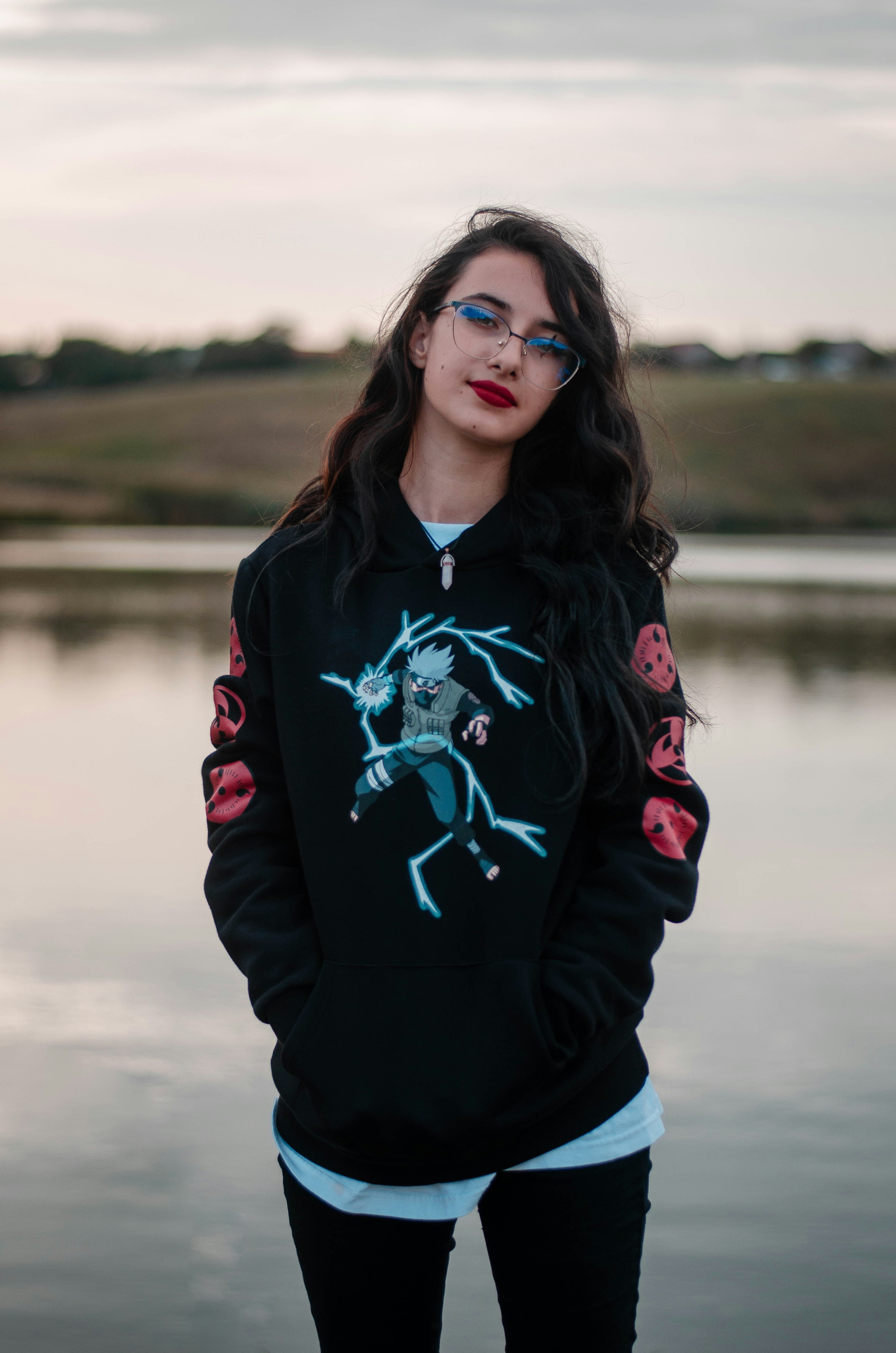 Neon Graphic Glow: A Hoodie-Clad Portrait by the Lake at Dusk