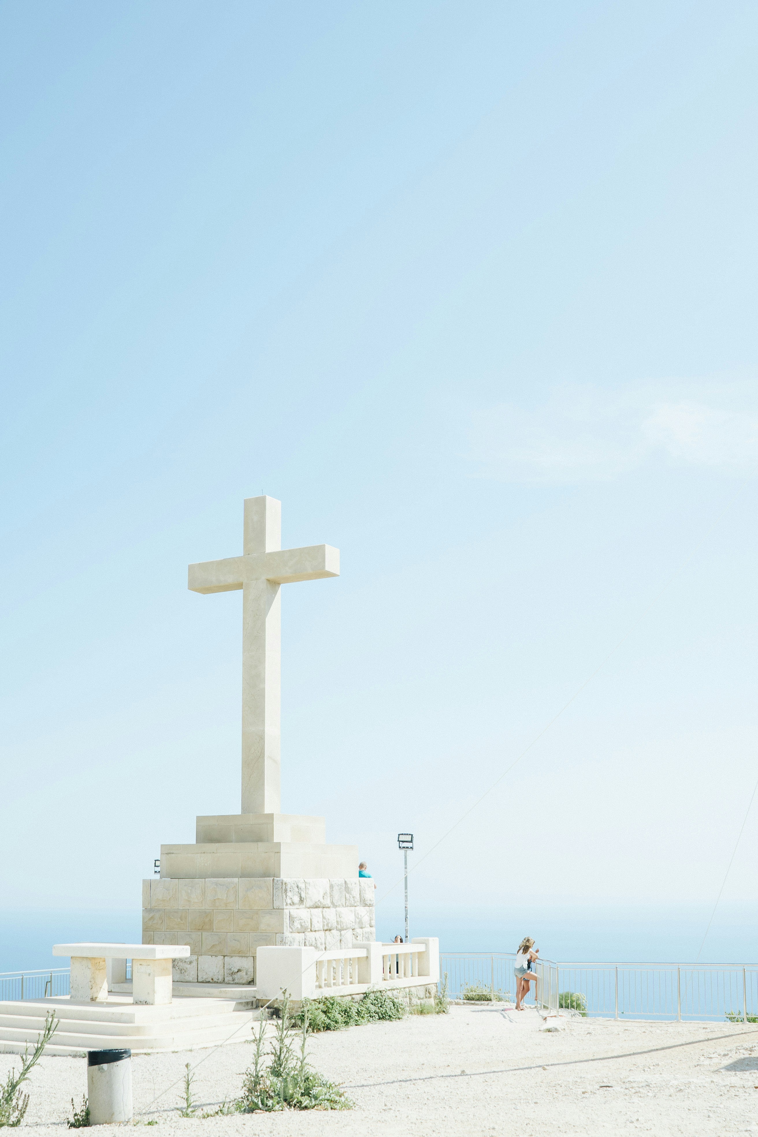 Silent monument by the sea under a pale blue sky