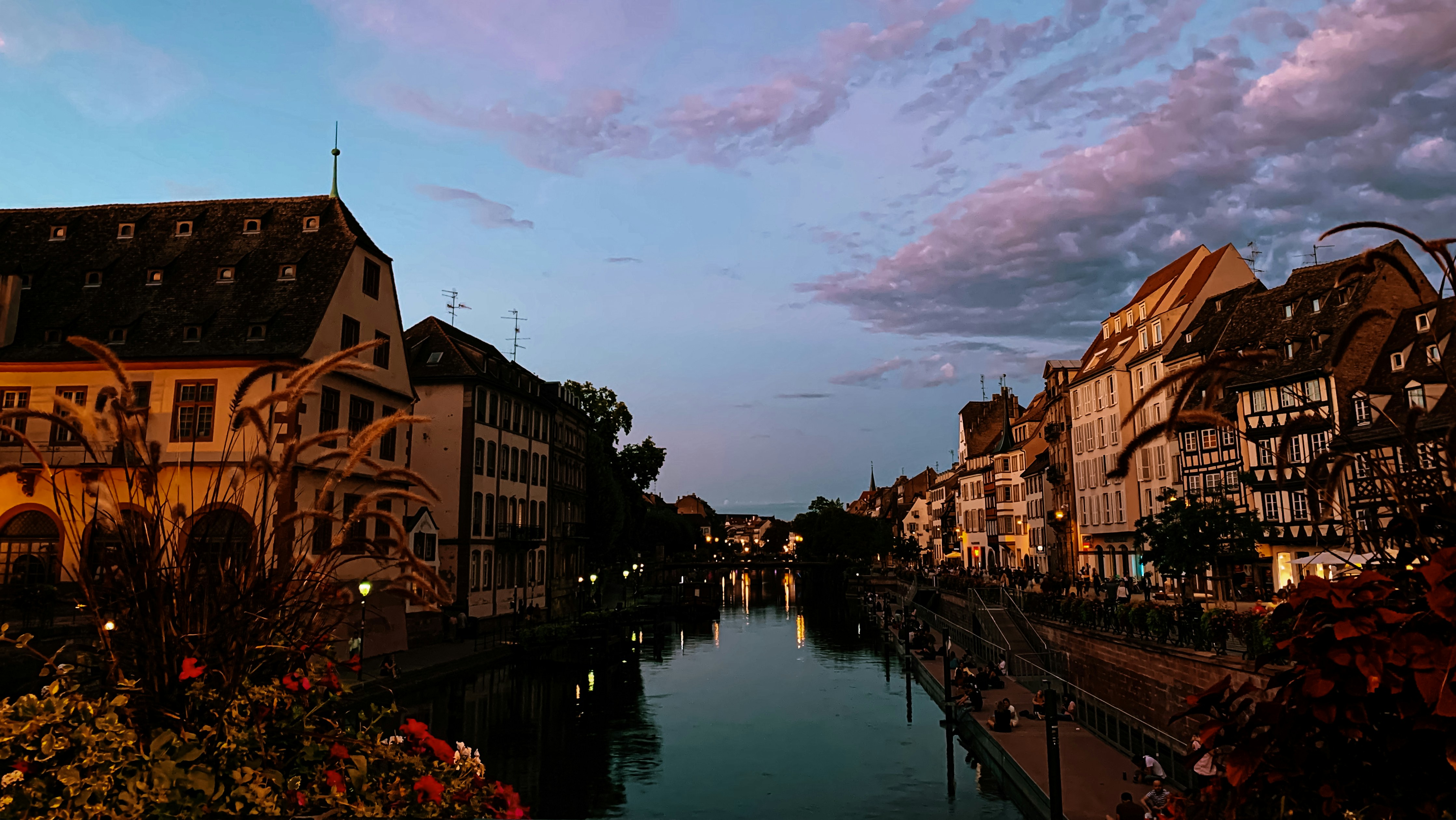 Charming canal scene at twilight, showcasing historic buildings and a serene waterway reflecting the evening sky.