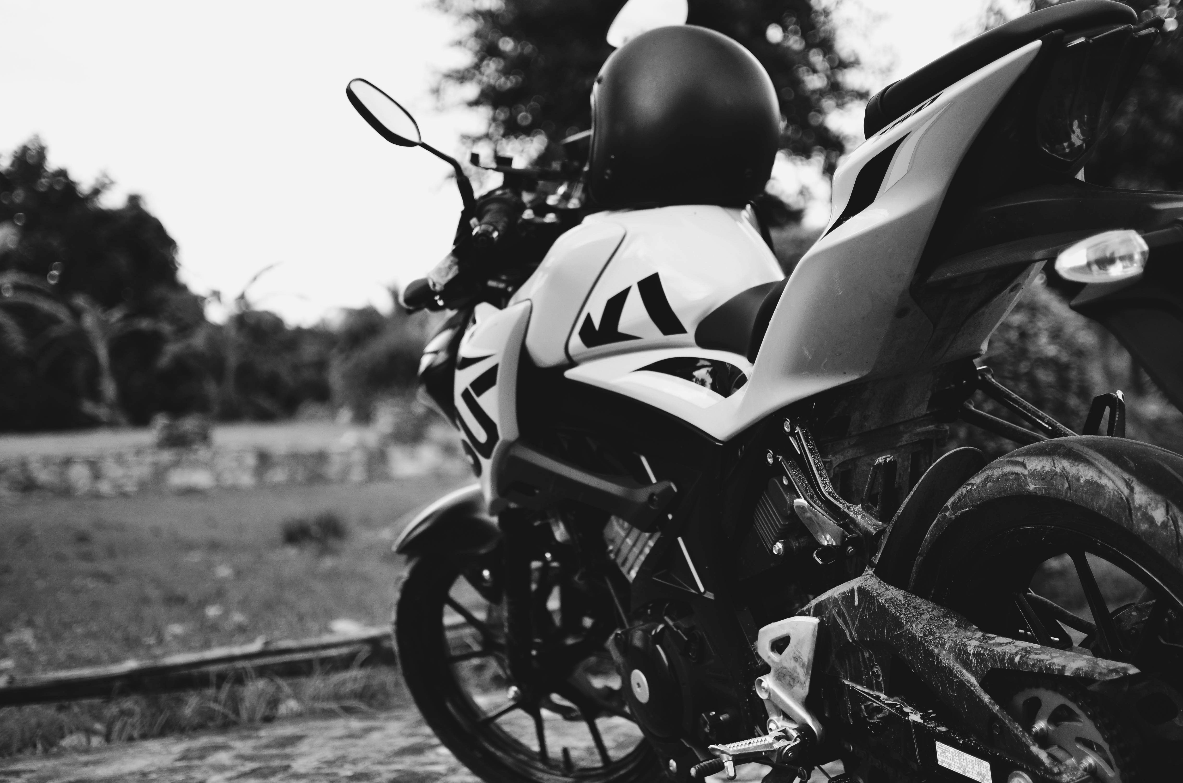 Noir Steel: a motorcycle rests by a quiet courtyard in monochrome