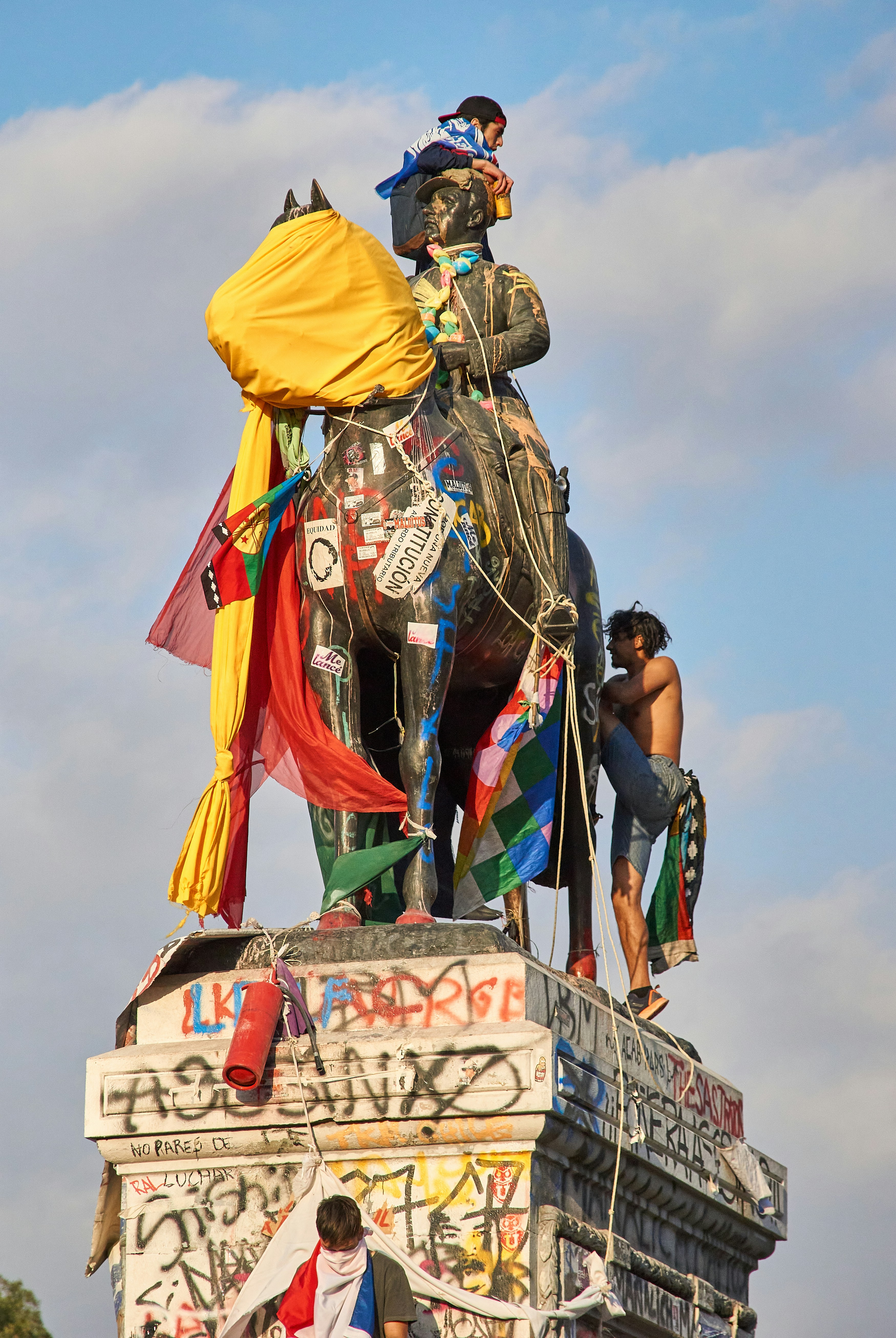 Carnival on a Monument: Color, Flags, and a Summit of Figures
