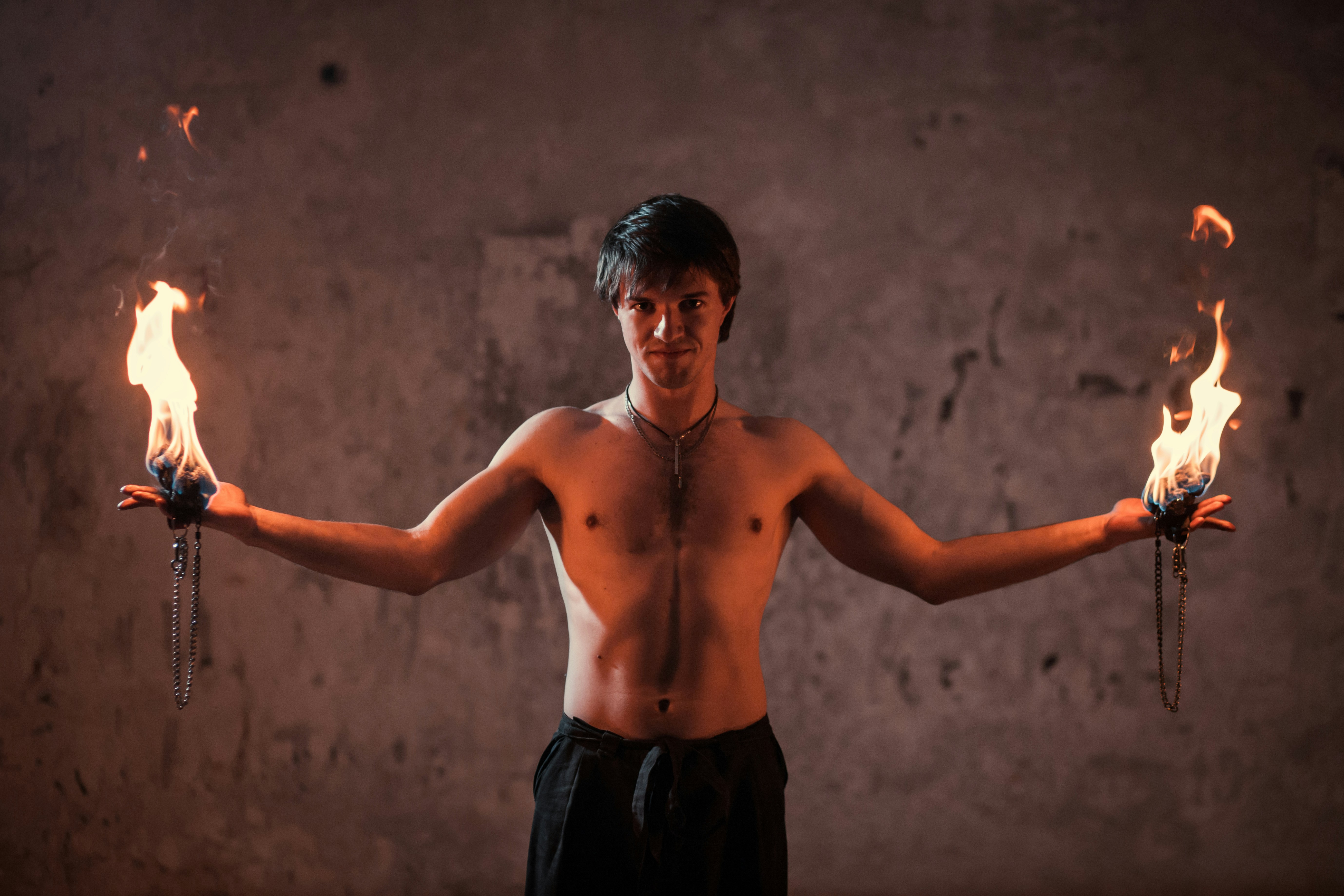 Flames of Focus: A Dual Torch Performer Stands Aligned