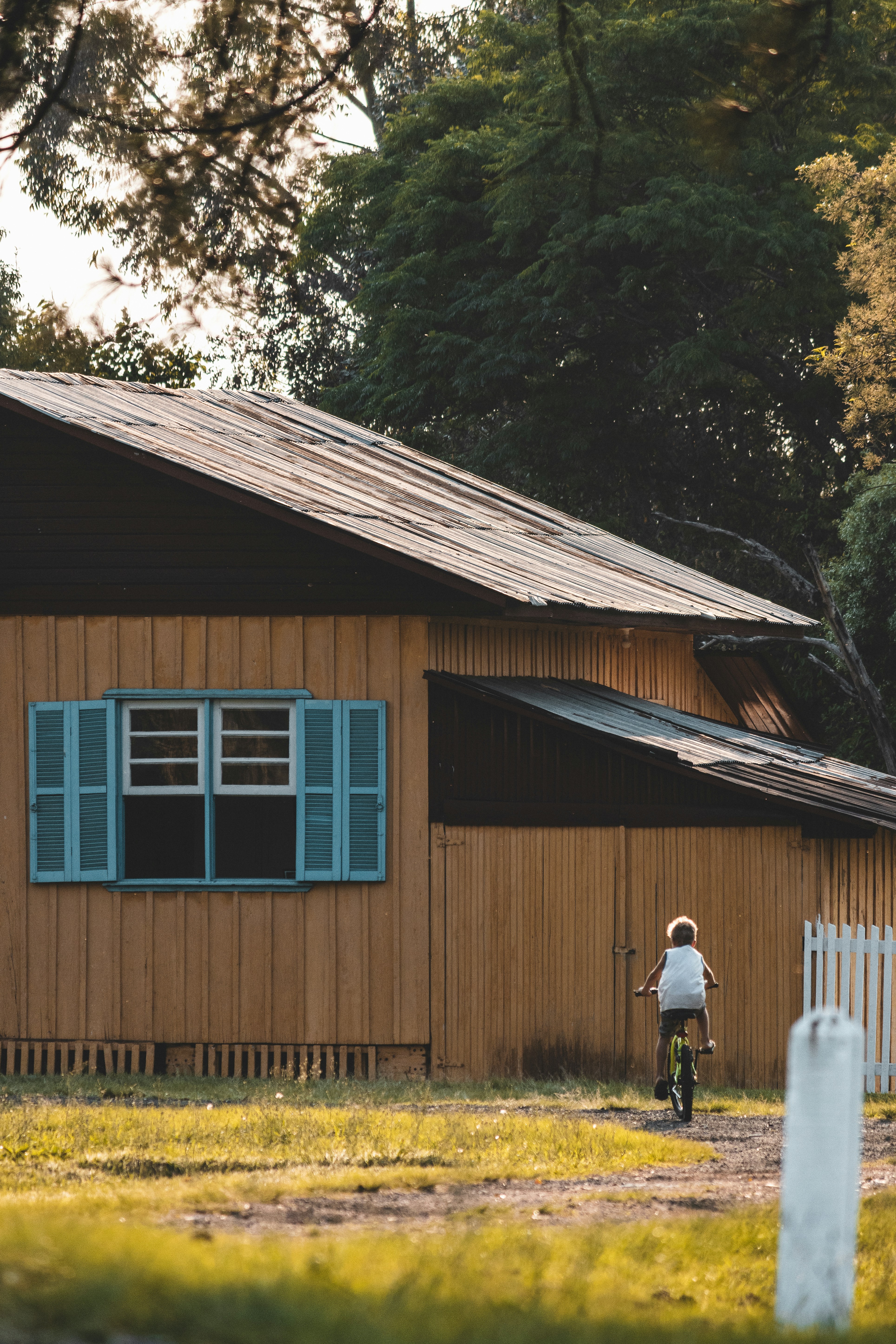 Toward the Blue Window: A Quiet Ride Past a Weathered Barn