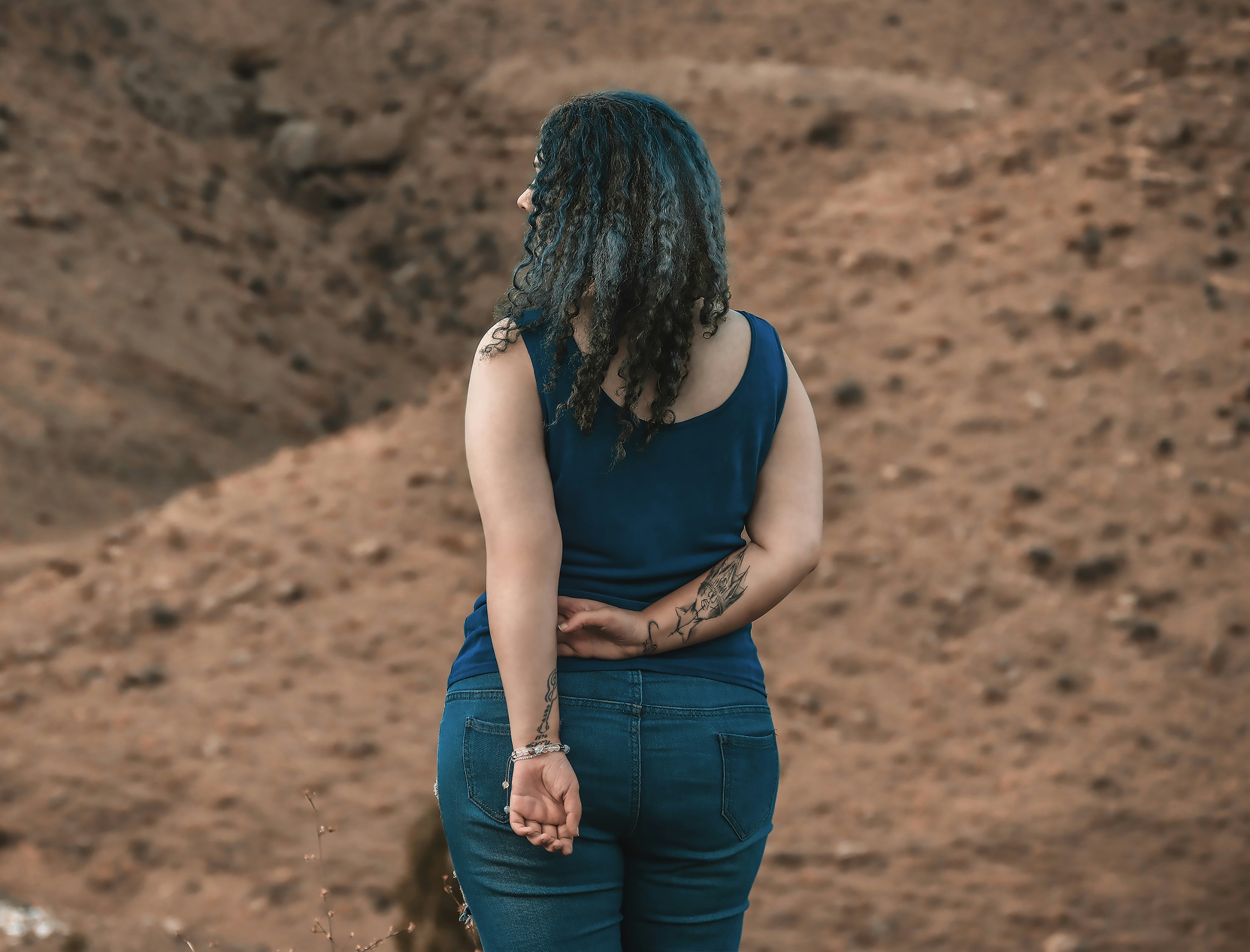 Back-Turned in Blue: A Quiet Portrait Amid Rusty Quarry Walls