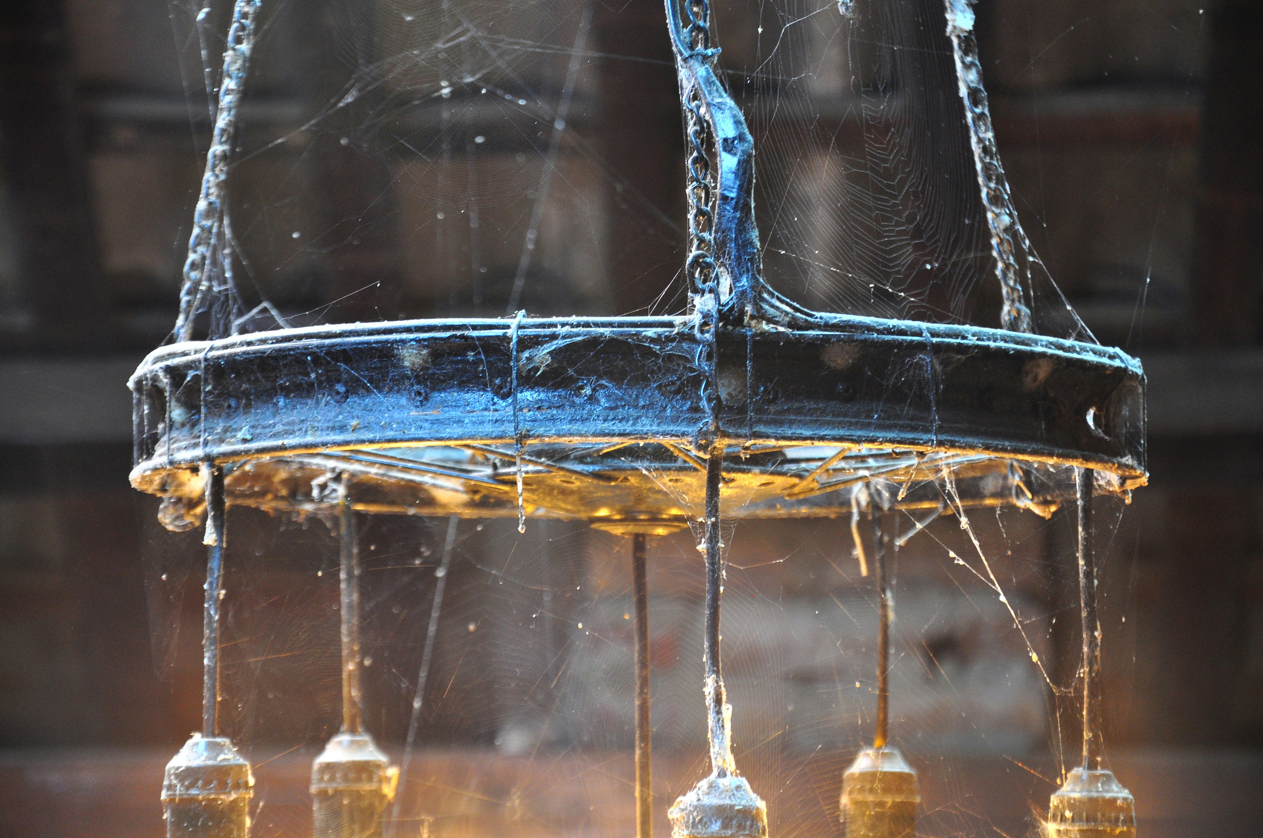 Cobwebs and Dust: An Aged Chandelier in Morning Light