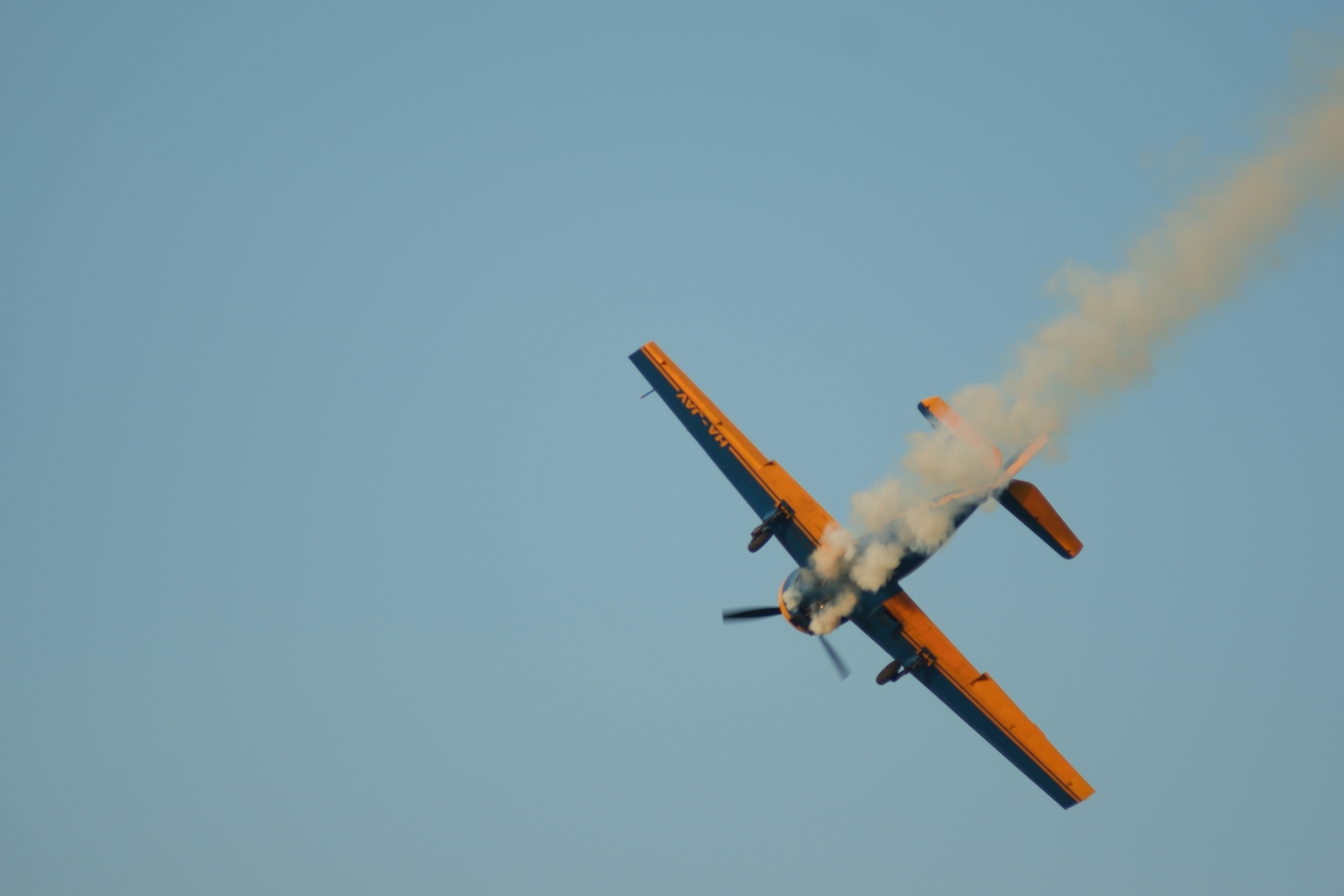Orange and white jet plane in mid air photo – Free Brown Image on Unsplash