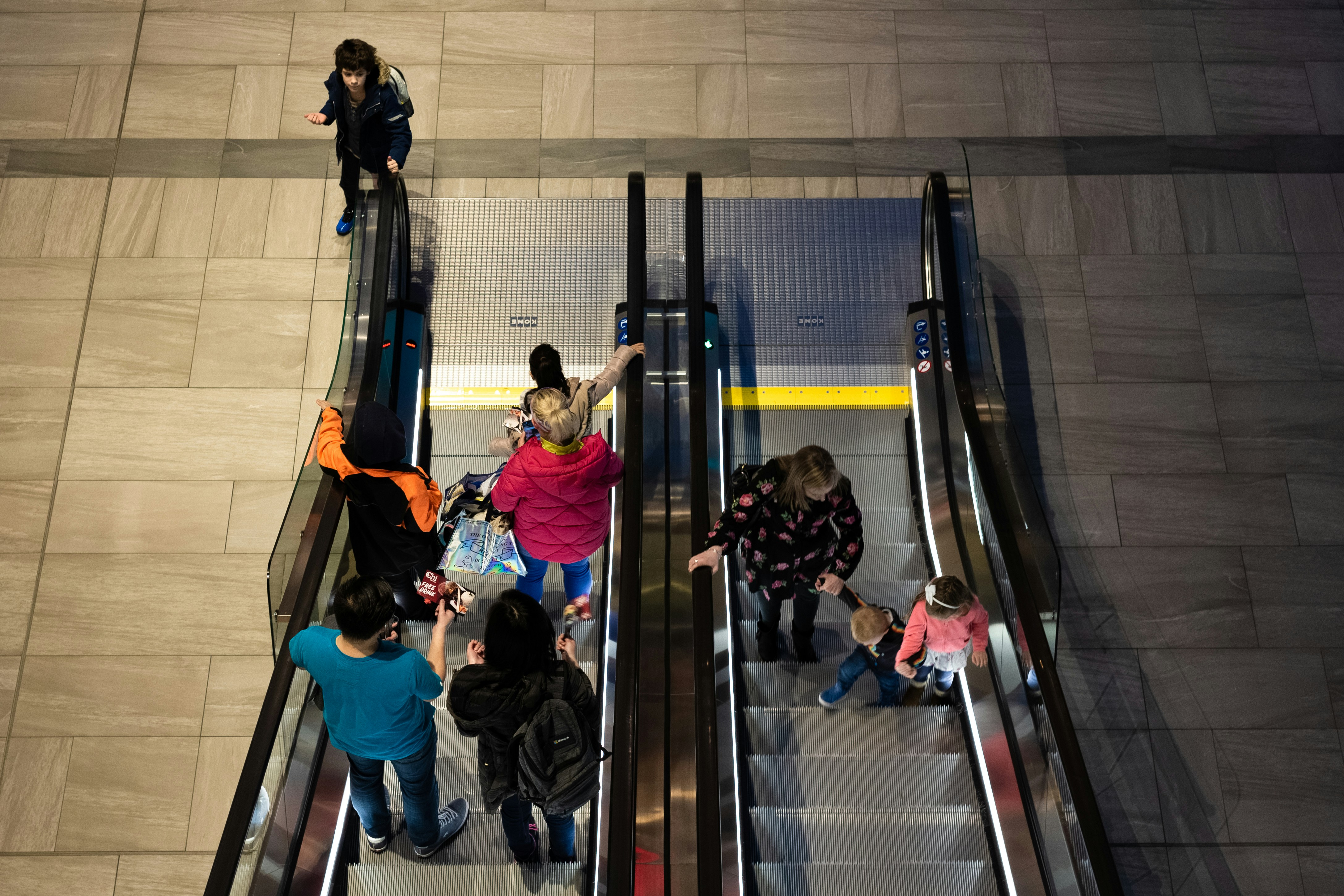 People walking on escalator inside building photo – Free Street Image ...