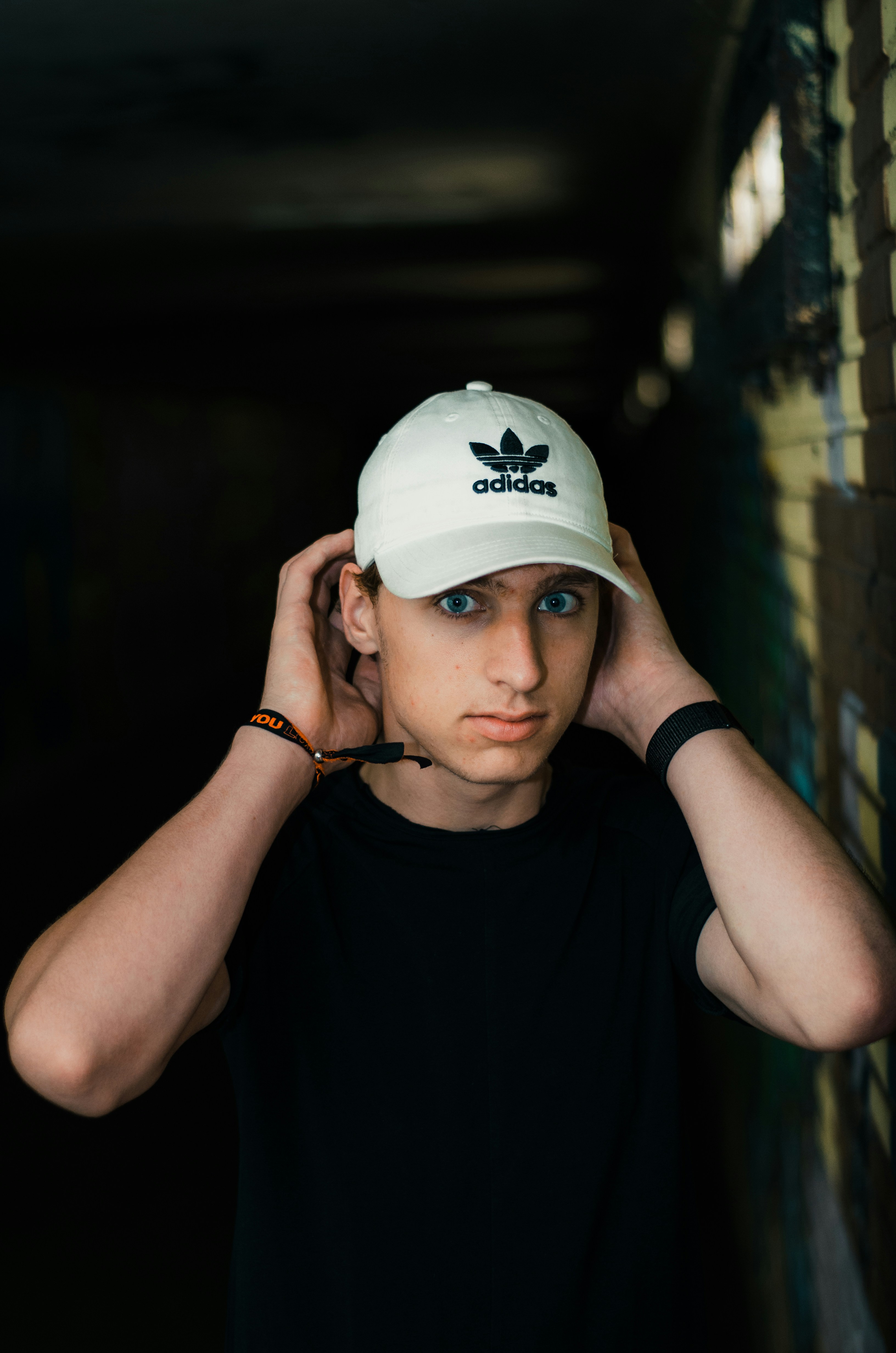 Glimpse of Focus: Portrait in a Shadowed Brick Corridor