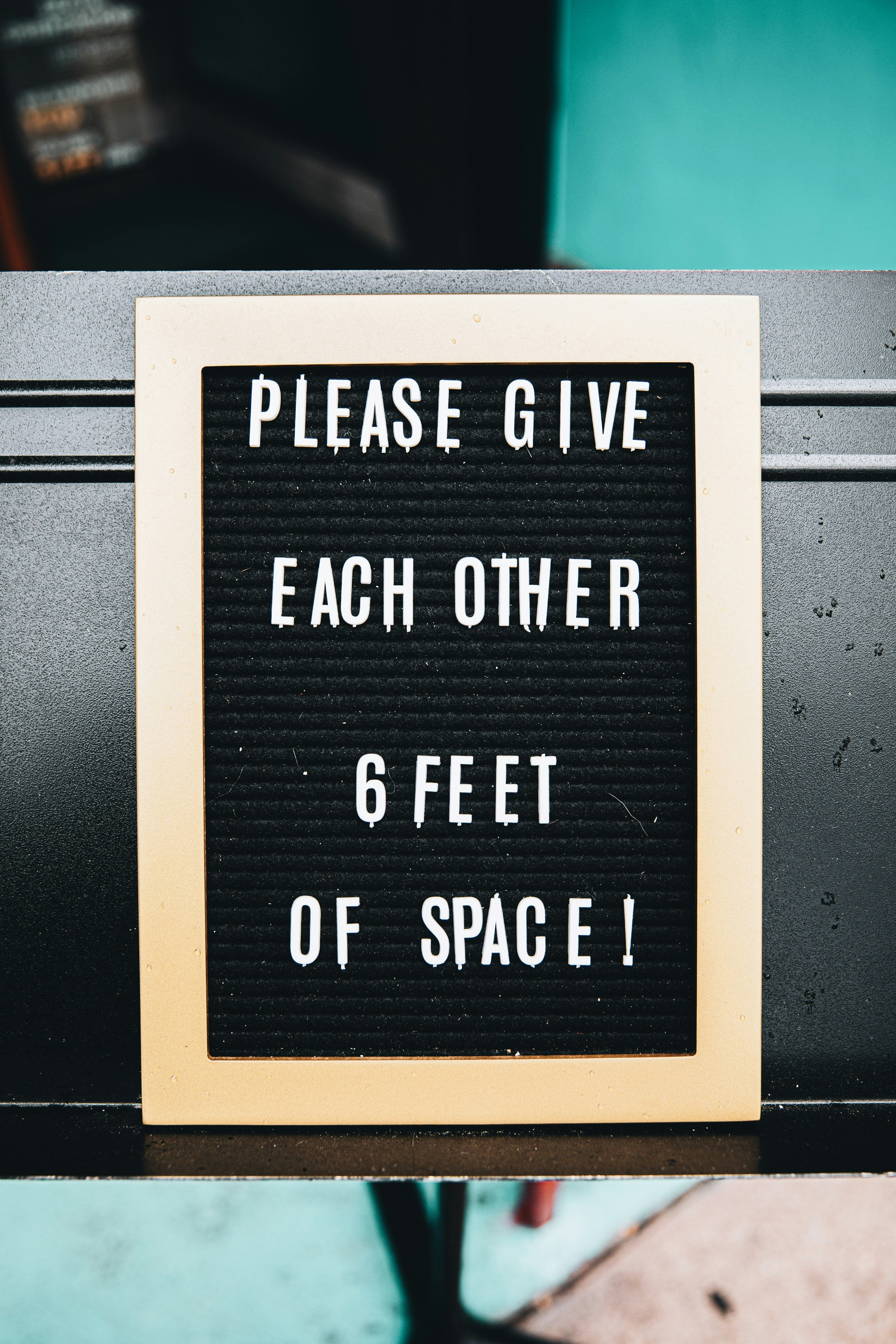 Six Feet of Space, Framed: A Distance Reminder on a Metal Ledge