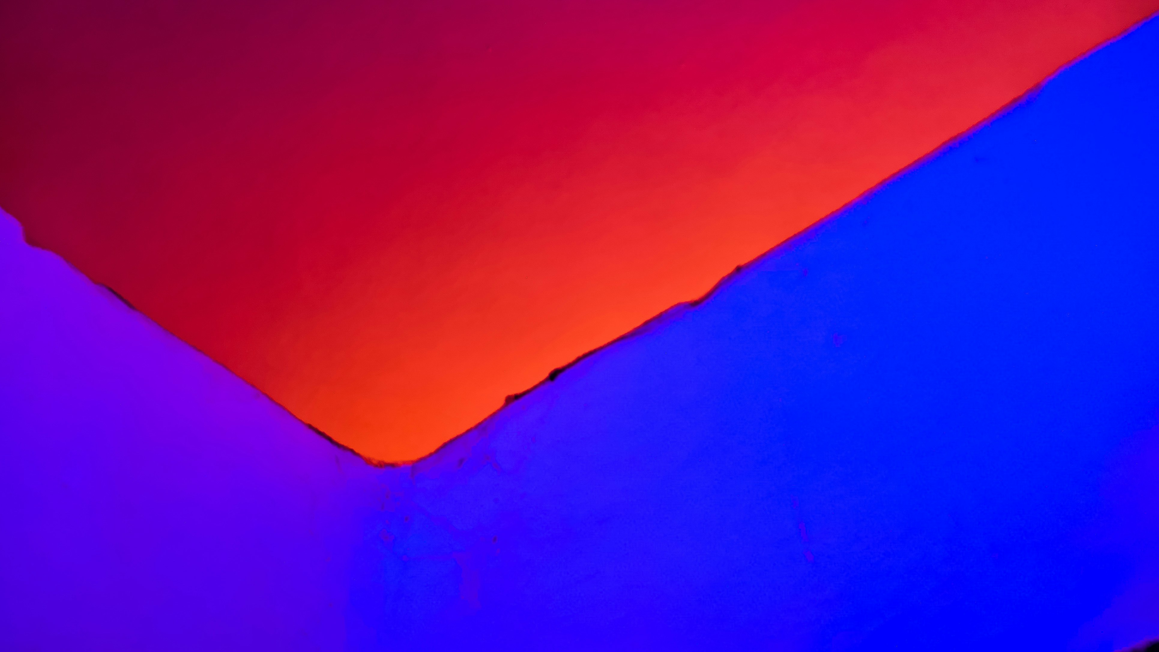 Abstract composition of vivid red and blue geometric shapes.