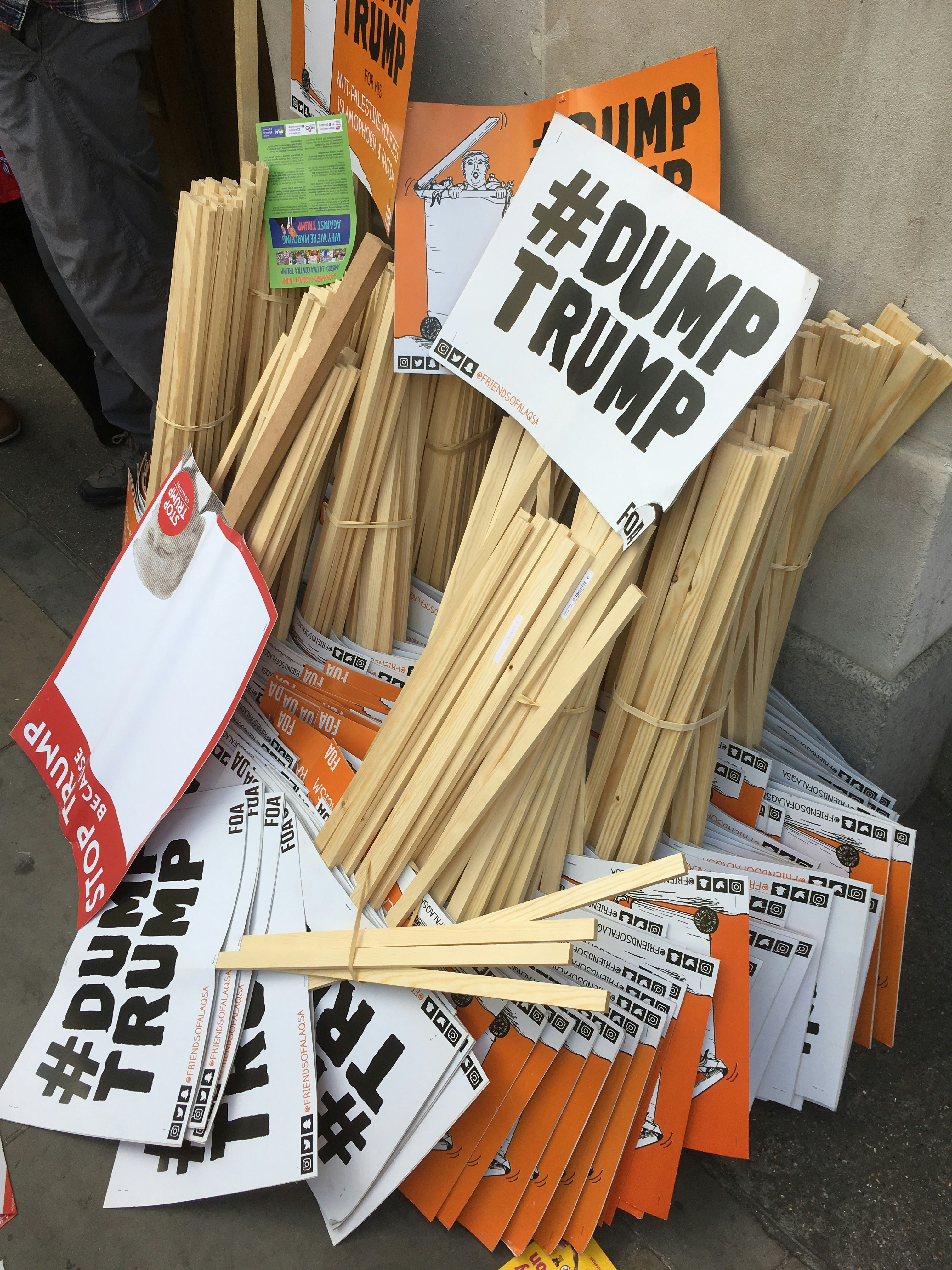 Stacks of Protest Signs: #DUMPTRUMP Leaning Against a Concrete Wall