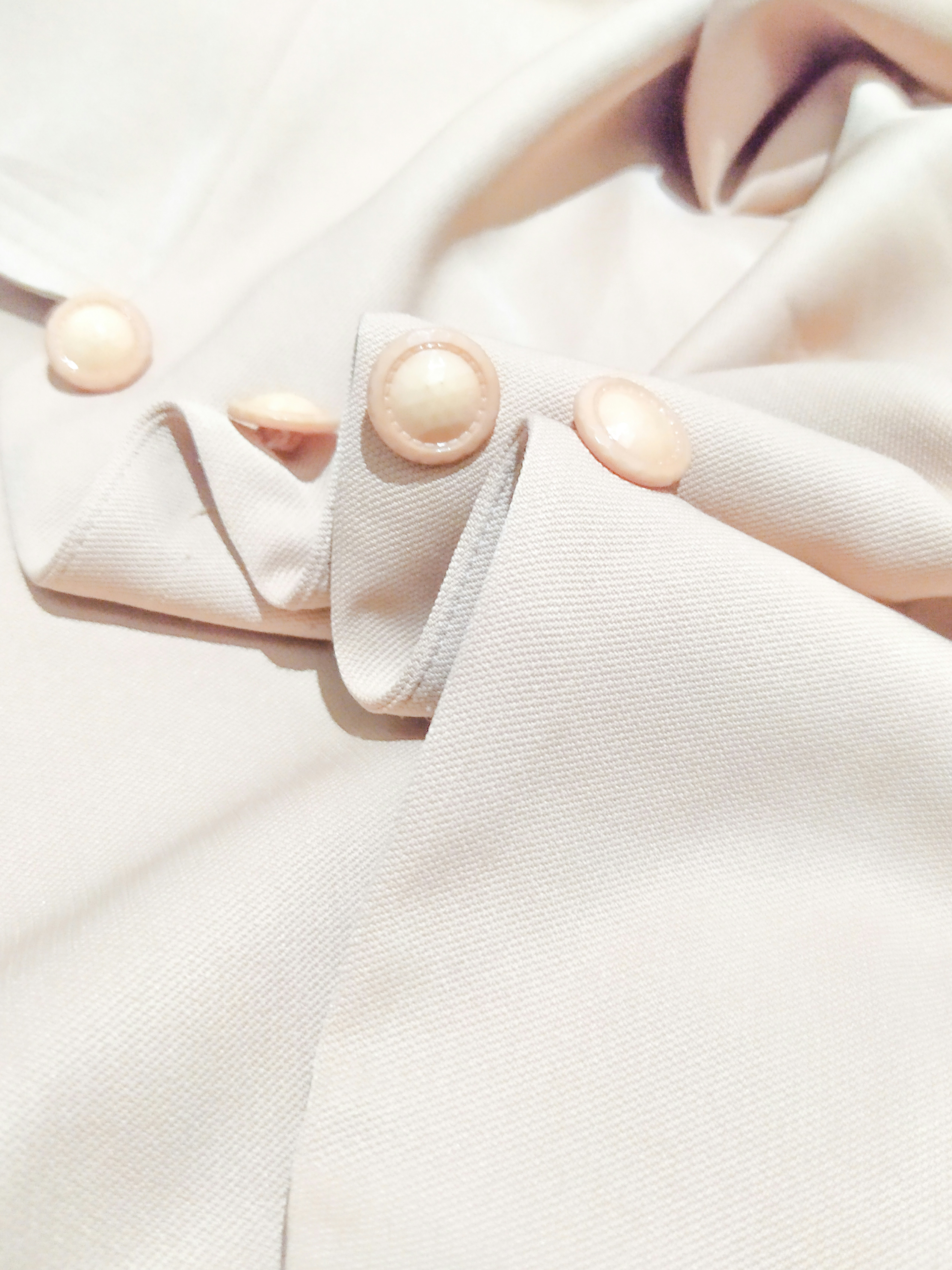 Buttons on folded fabric | white button up dress shirt