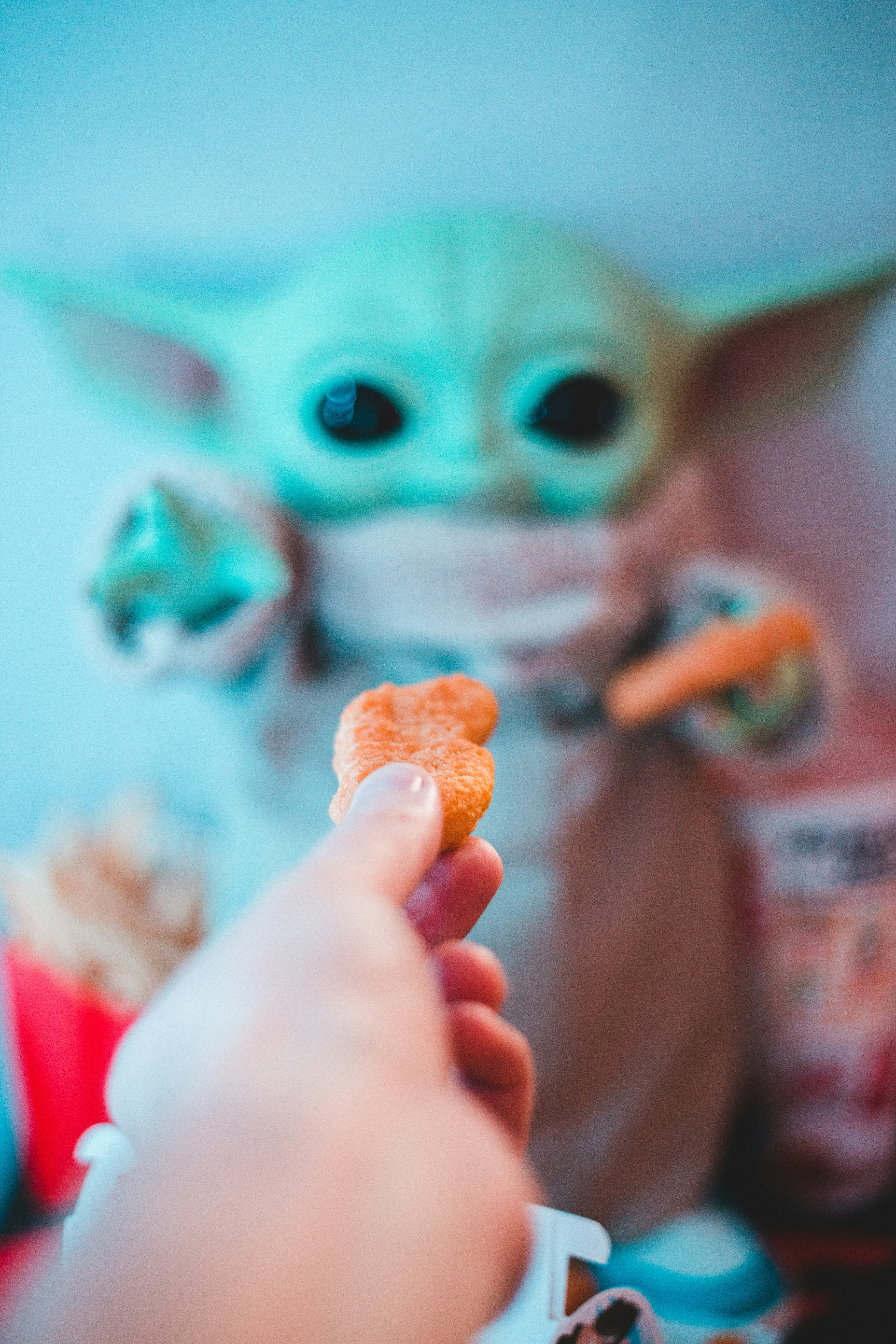 Tiny Hand, Big Moment: The Childlike Grogu Holds a Snack toward the Camera