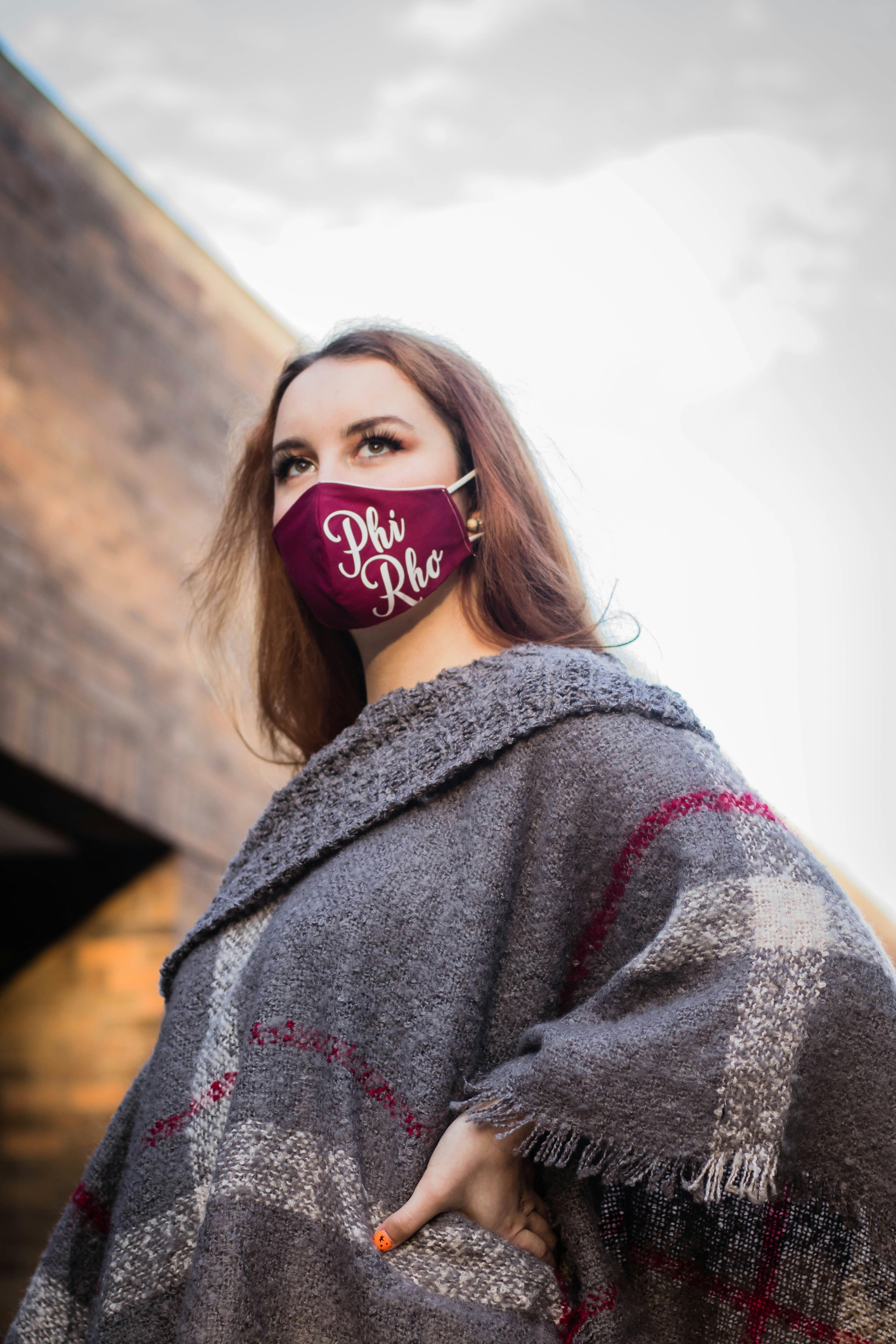 Phi Rho Masked Portrait Under a Weathered Brick Canopy