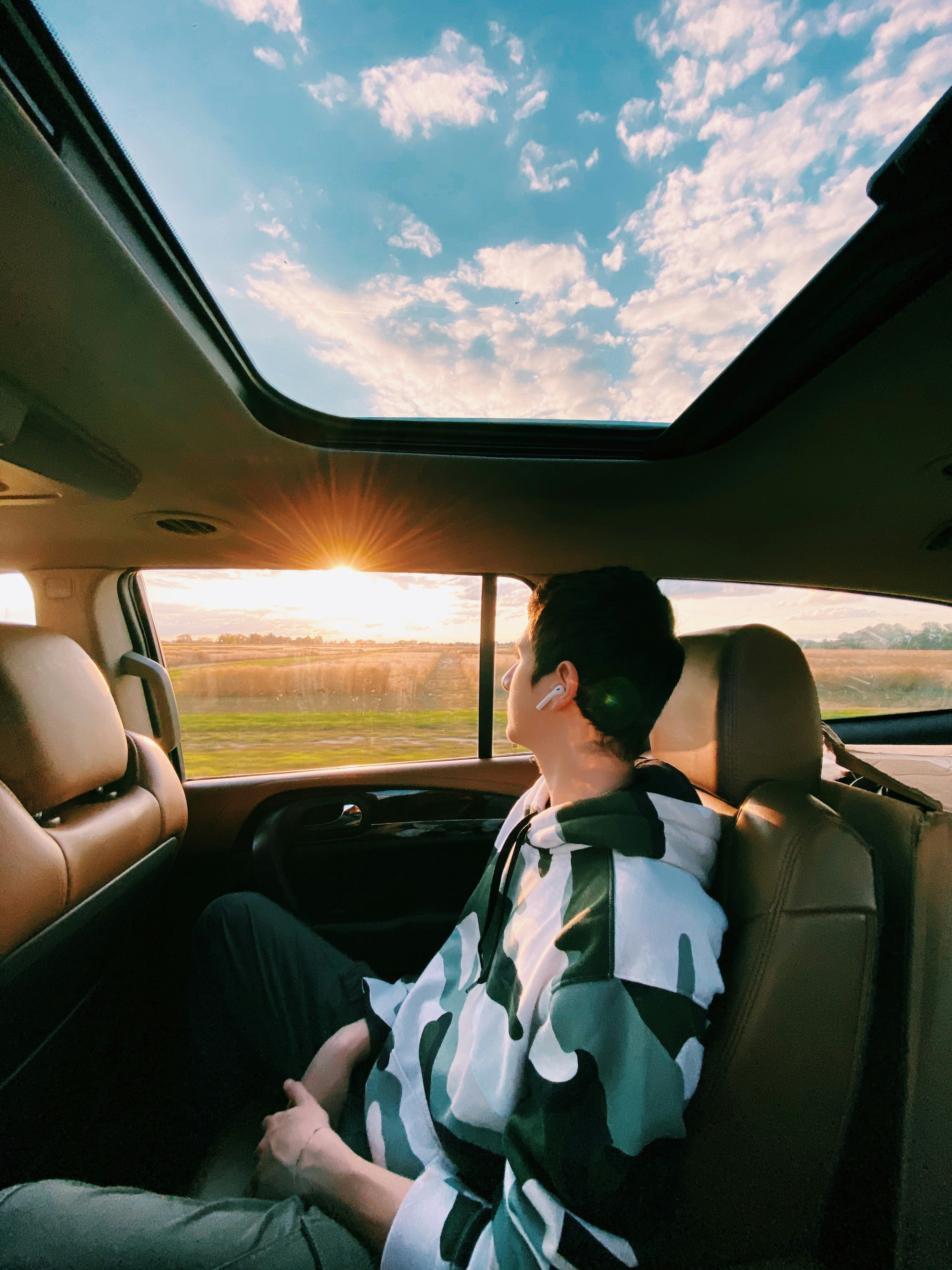Sunburst in the Back Seat: Golden Hour Through the Open Sunroof